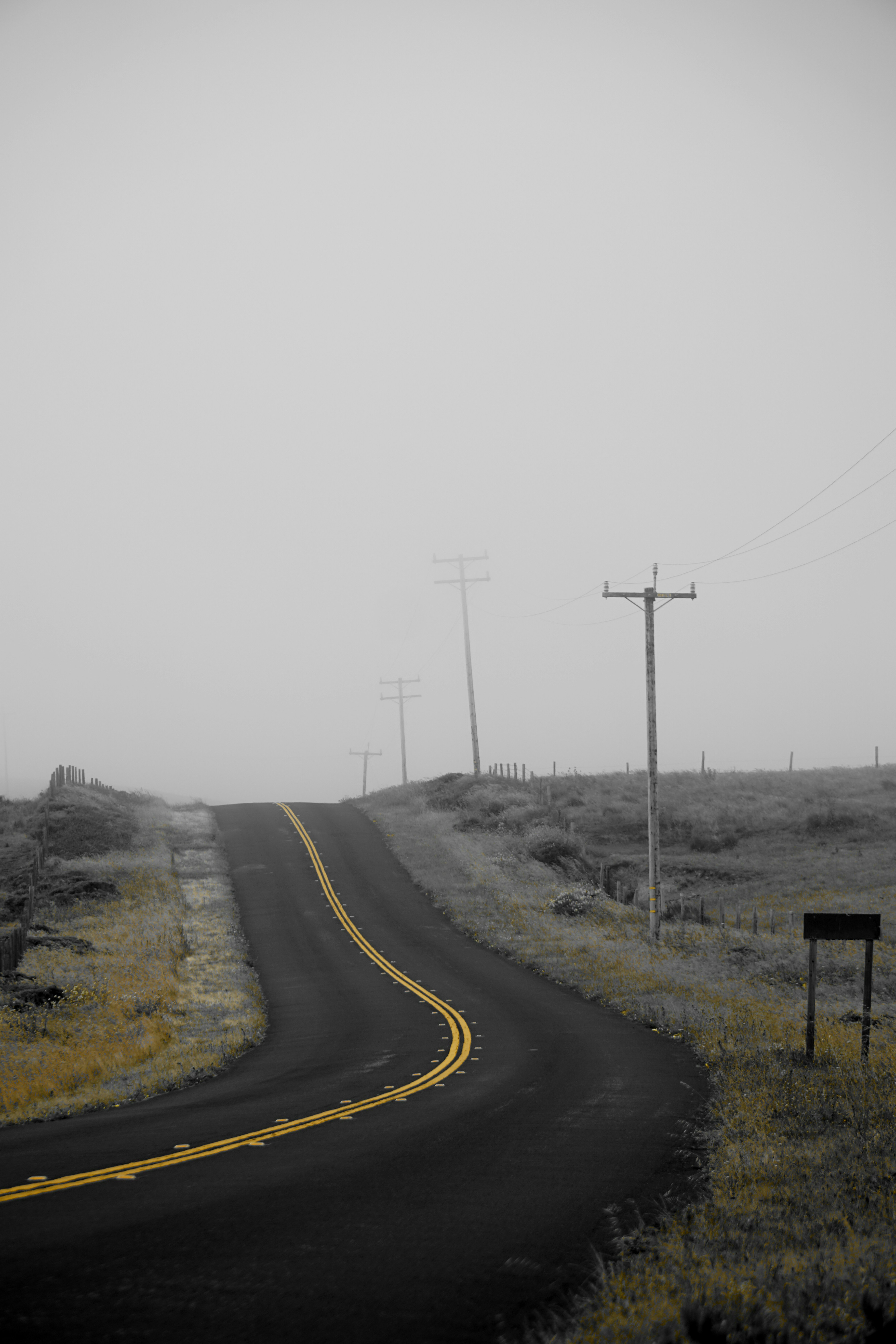 asphalt road under cloudy sky