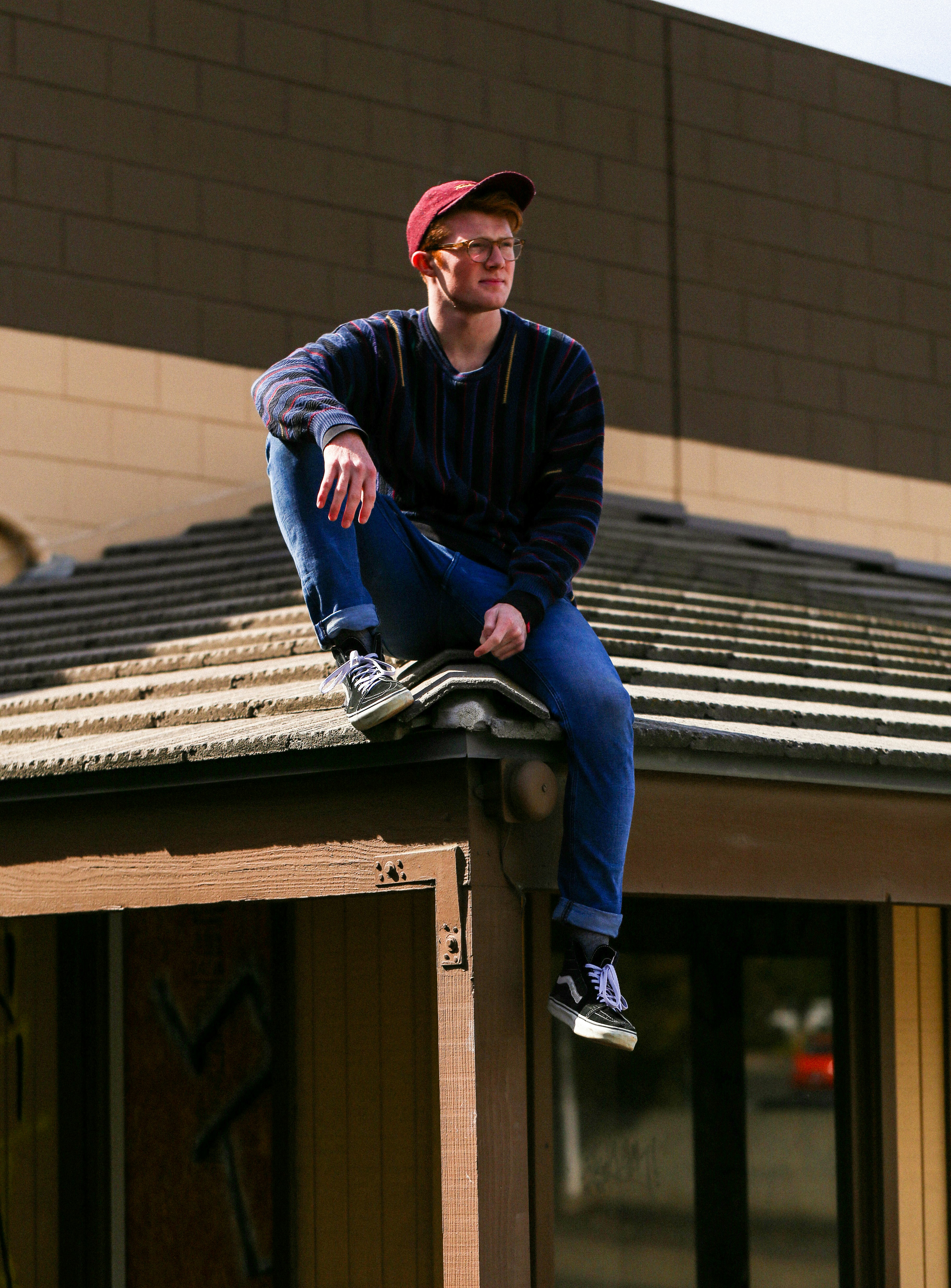 Person sitting on roof photo – Free Person Image on Unsplash