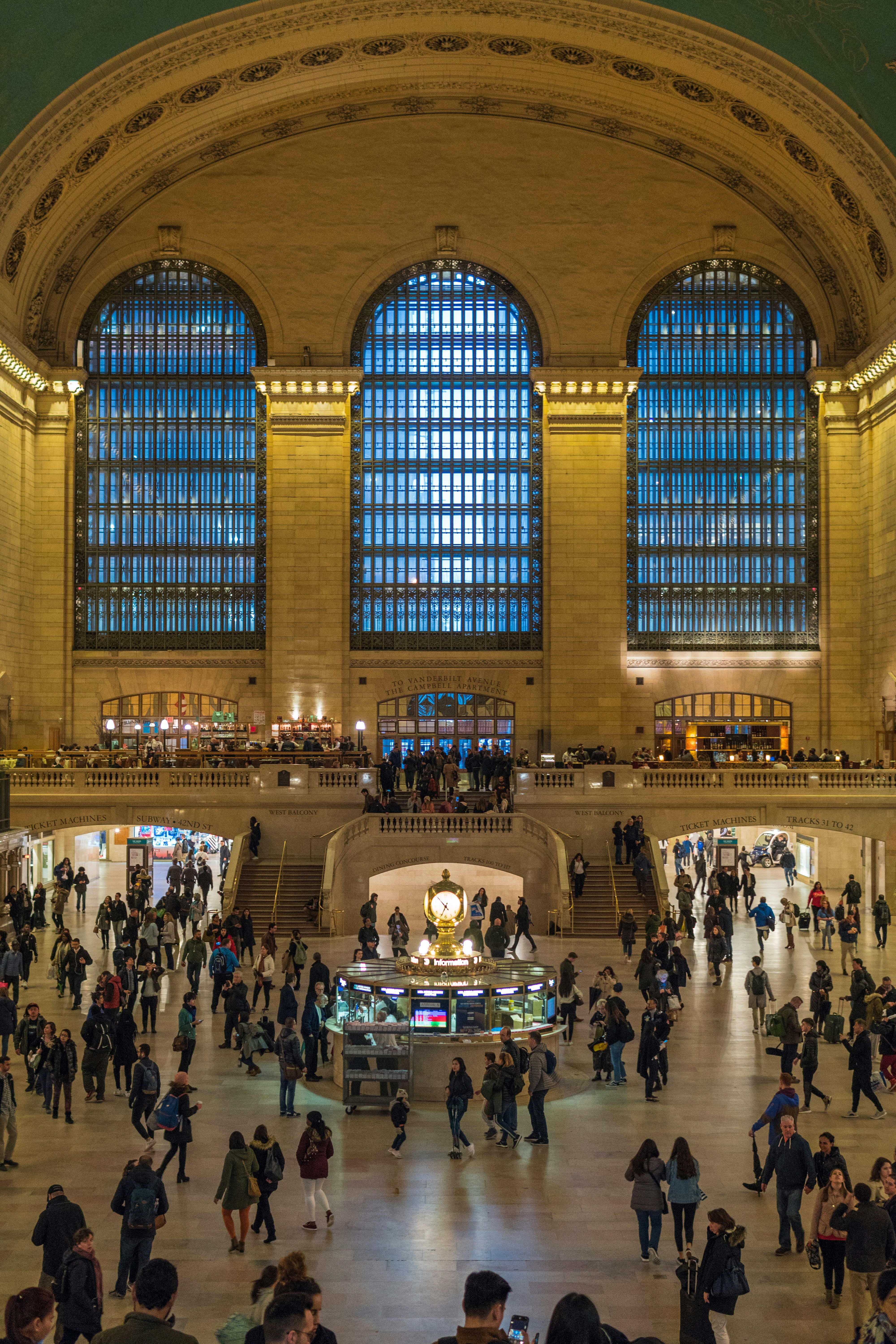 Grand Central | group of people standing on brown wooden surface