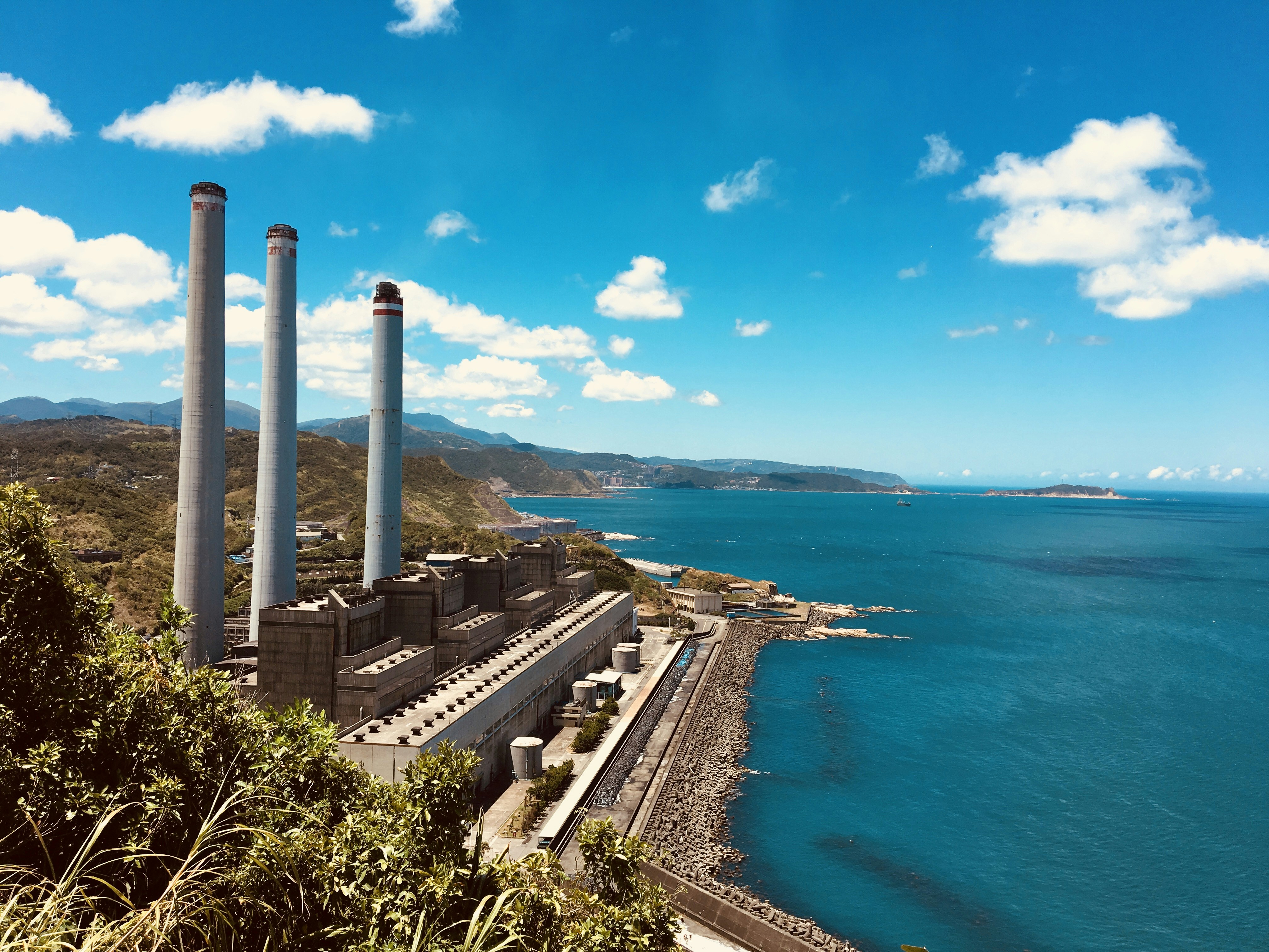 Gray and brown factory near sea under blue sky photo – Free Water Image ...