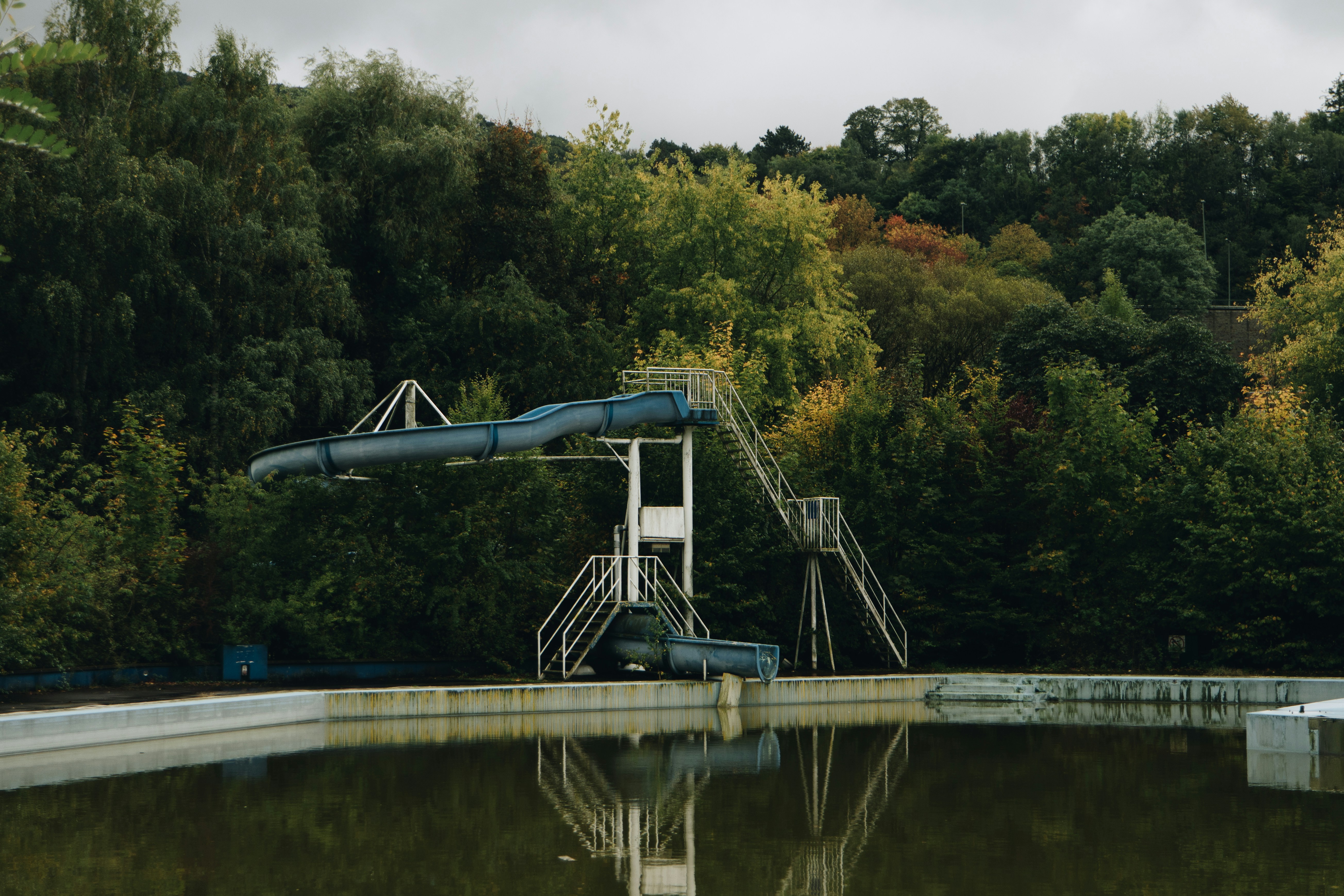 Abandoned swimming pool | slide leading towards pool