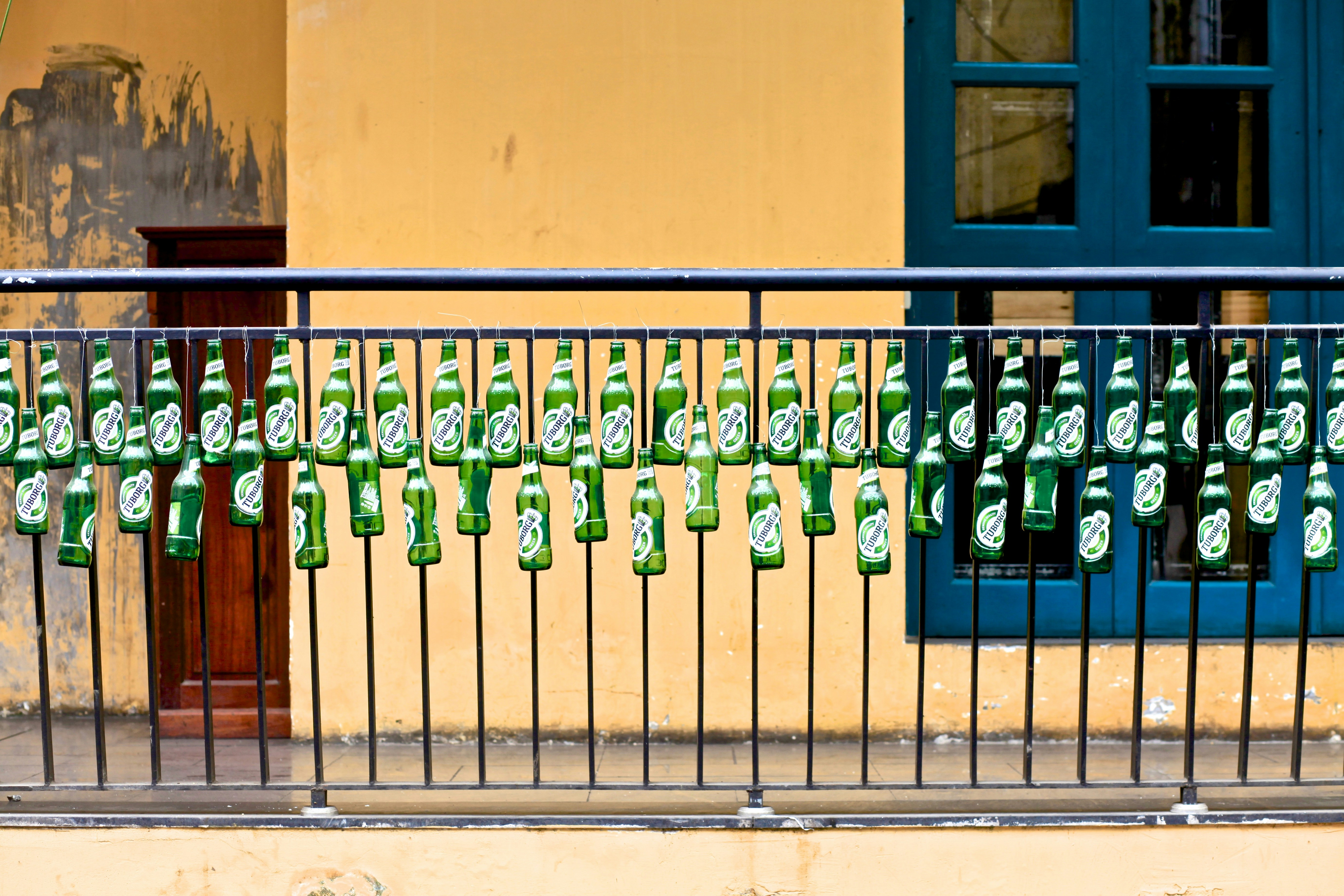 Bottled Rhythm Along a Balcony Rail
