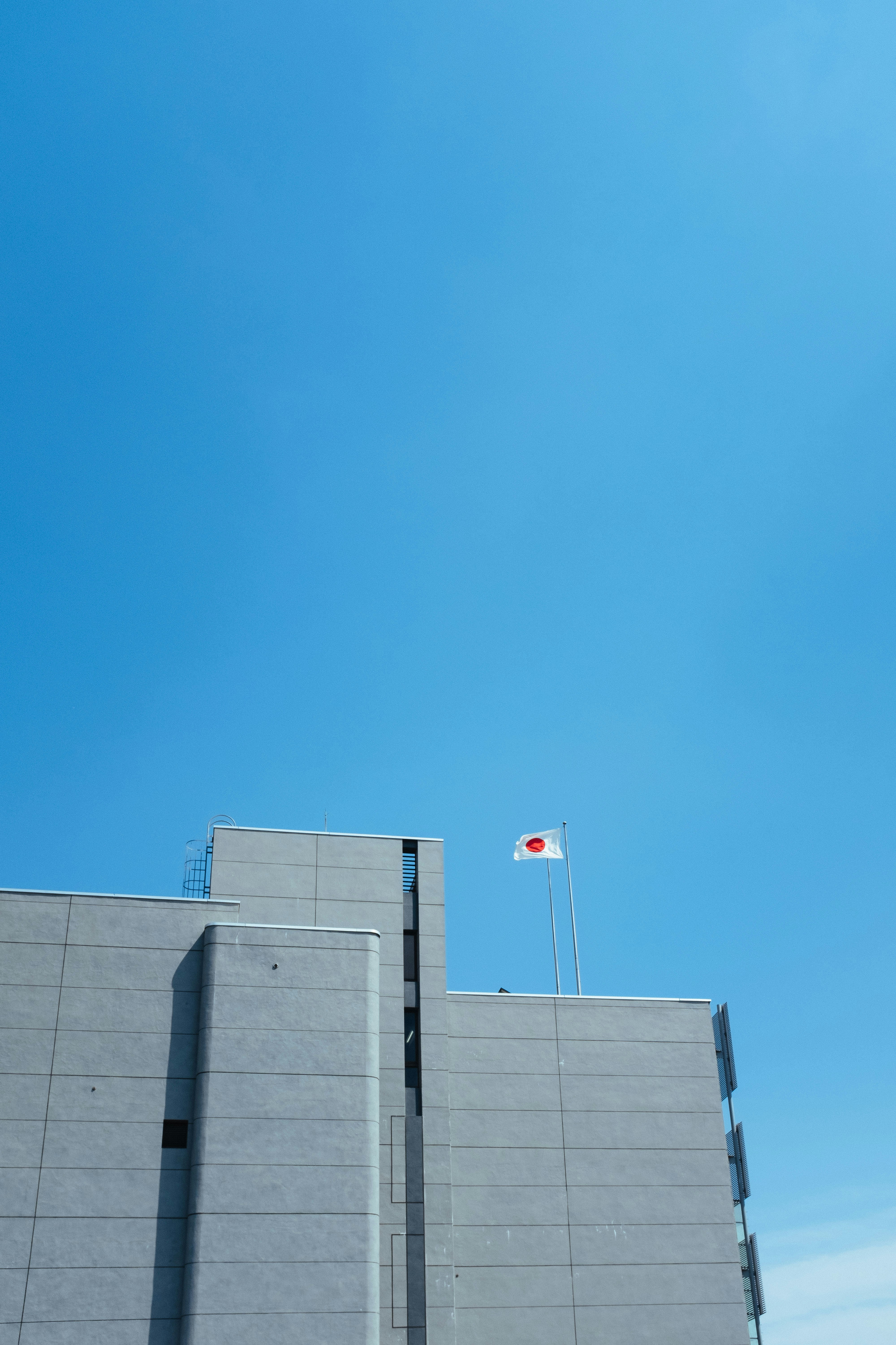 Flag of Japan on top of building photo – Free Tokyo Image on Unsplash