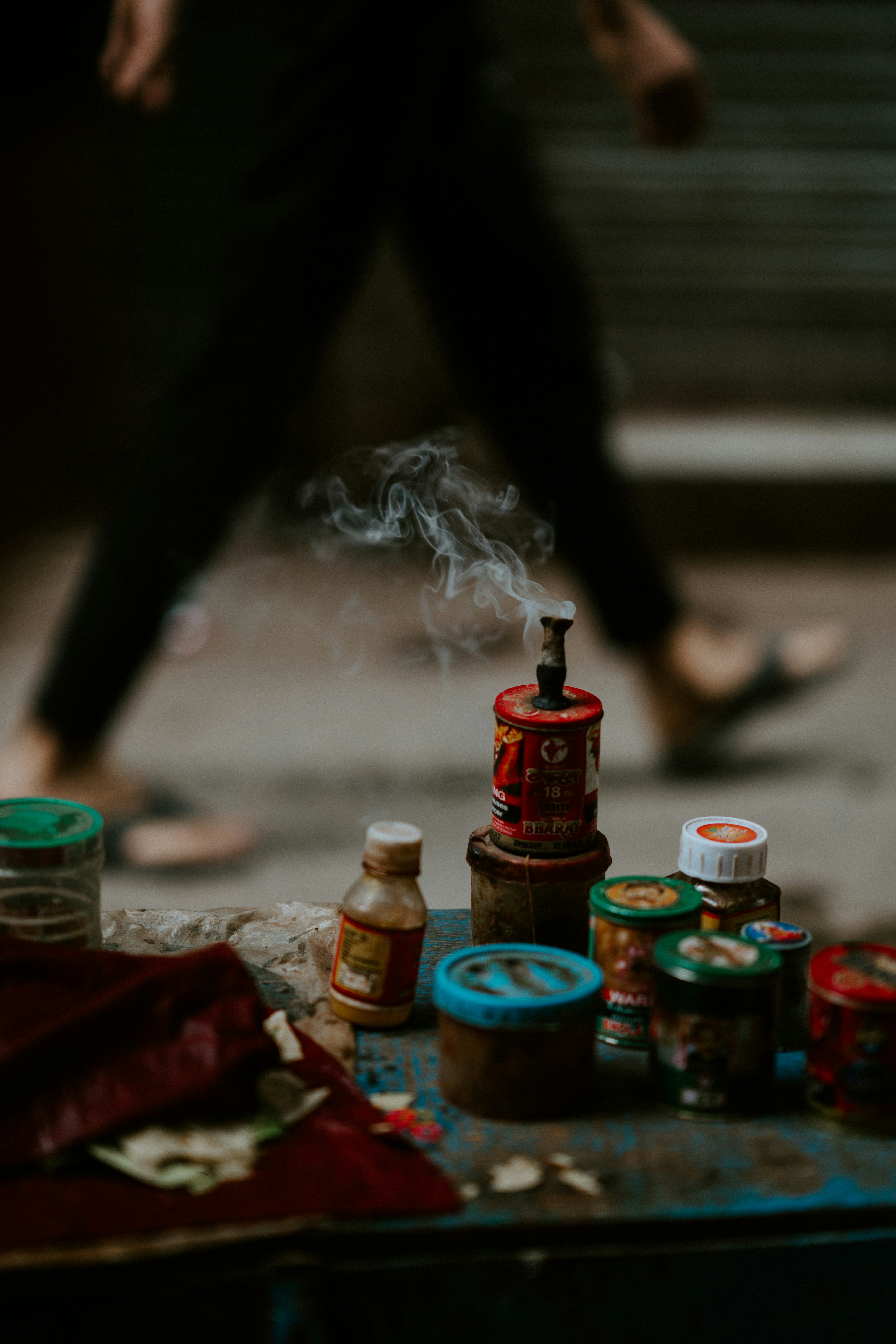 Smoked Flame and Spilled Colors: A Street Still Life at Dusk