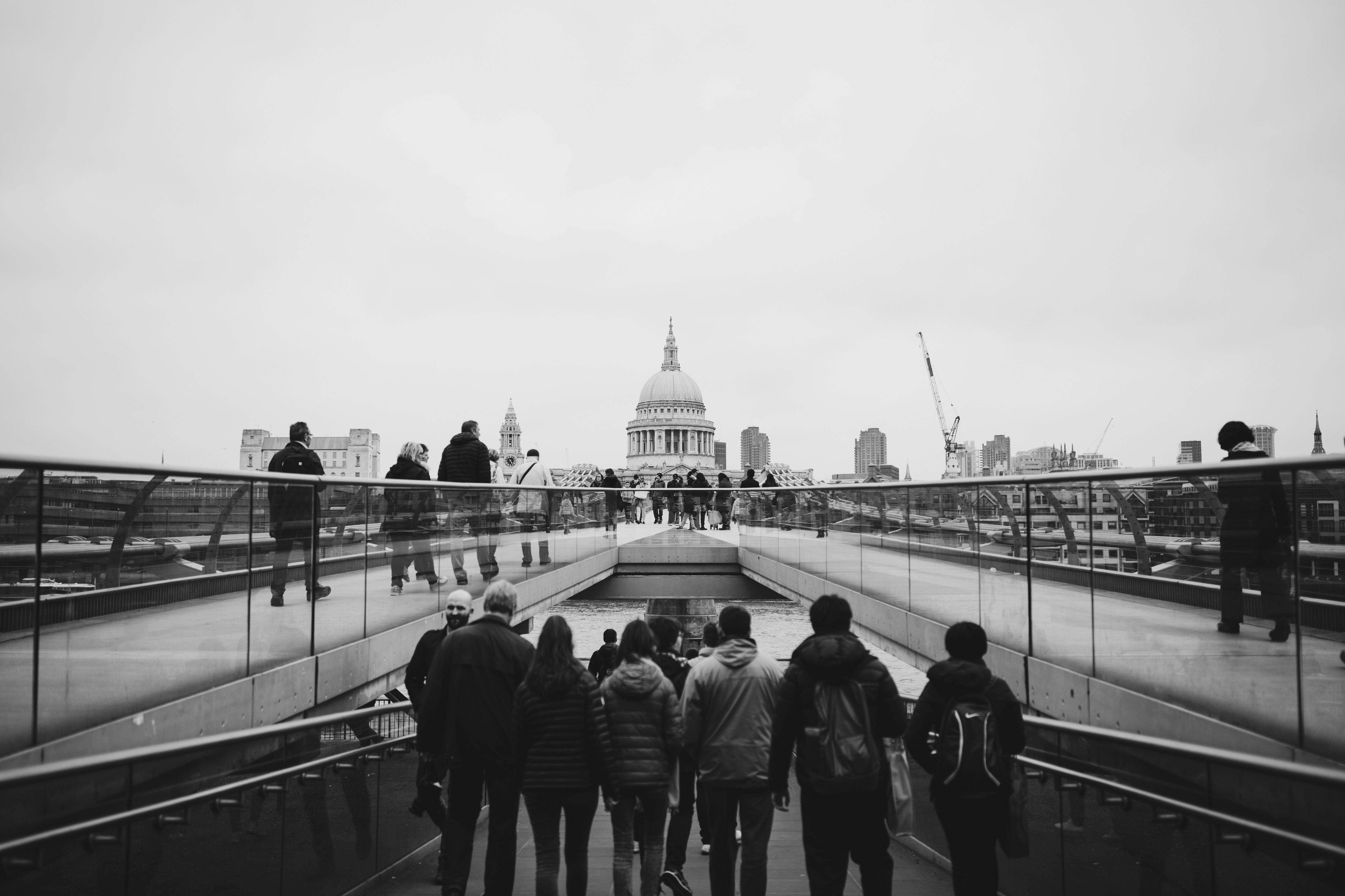 Monochrome Convergence: Footfall Toward St. Paul’s on Millennium Bridge