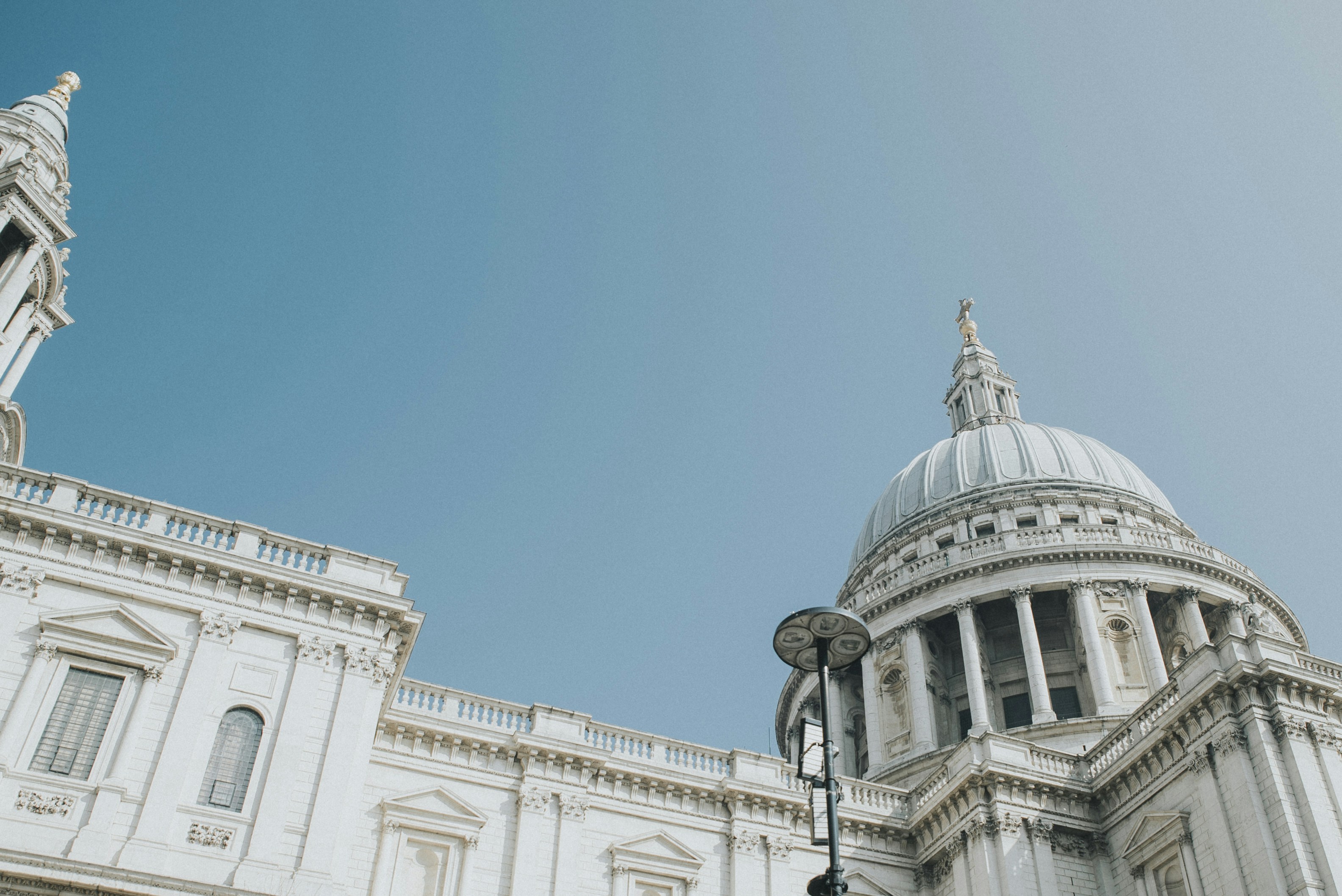 Cathedral dome and spire against a clear blue sky.