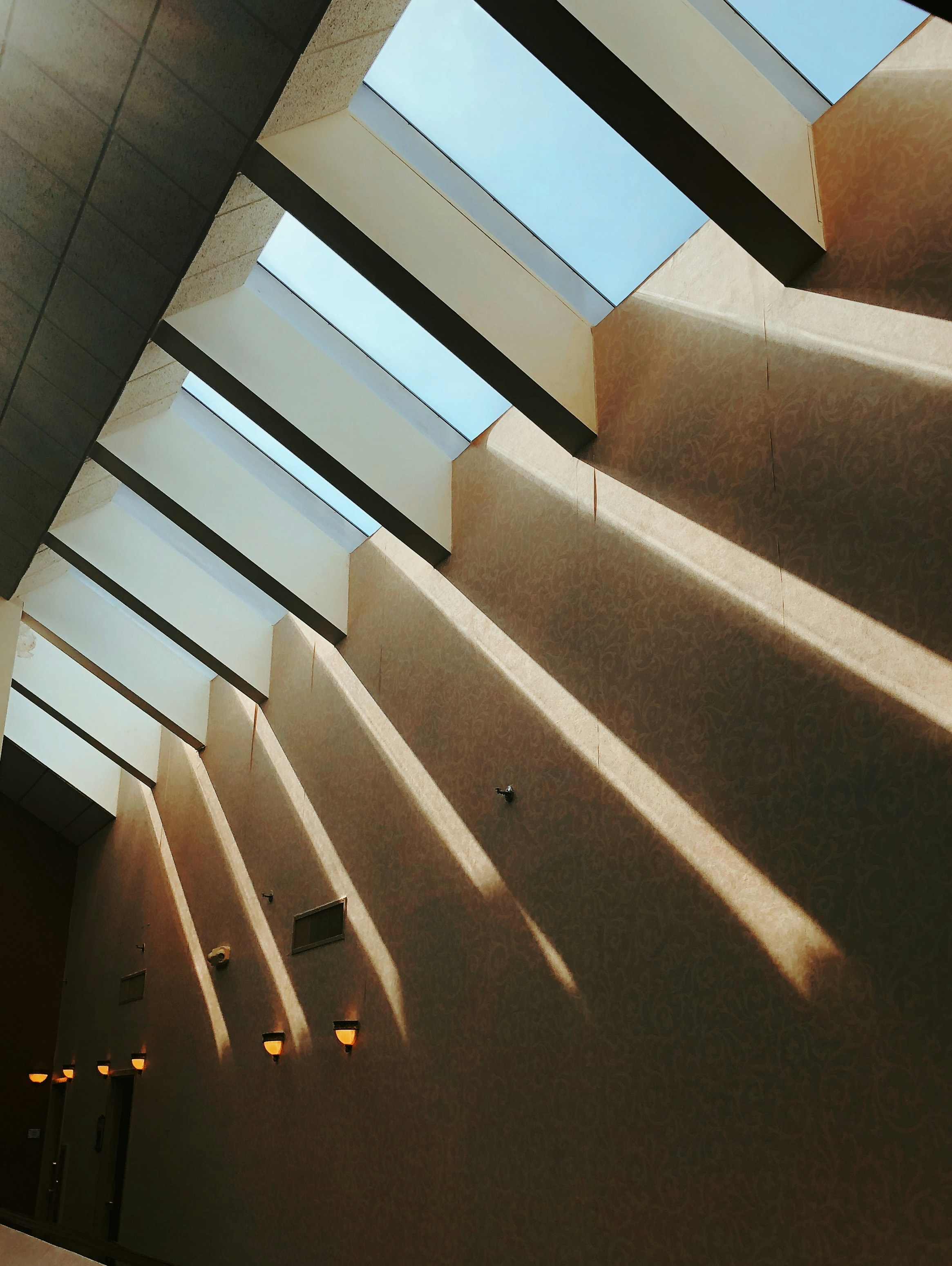 A building with a skylight and a set of stairs photo – Free Light Image ...