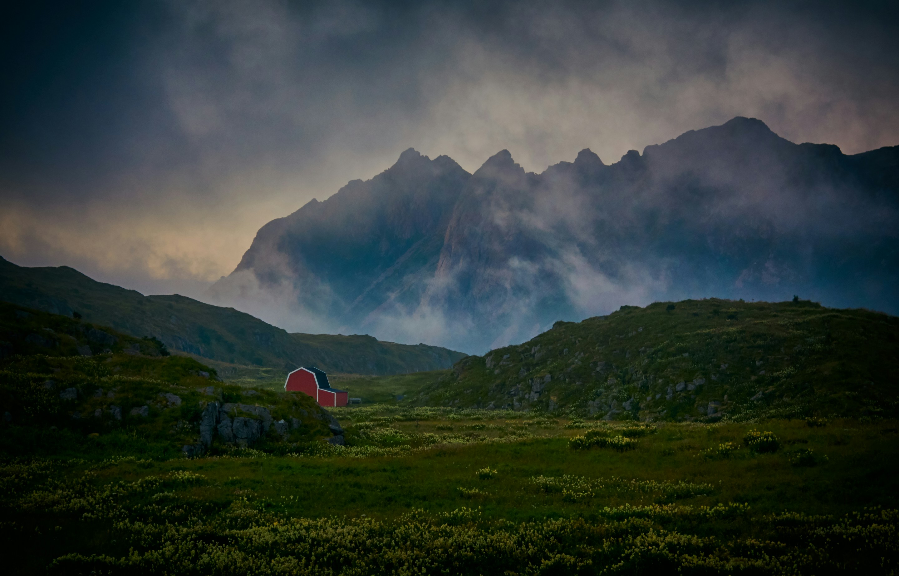 Red Barn | red house near hills covered with smoke at daytime