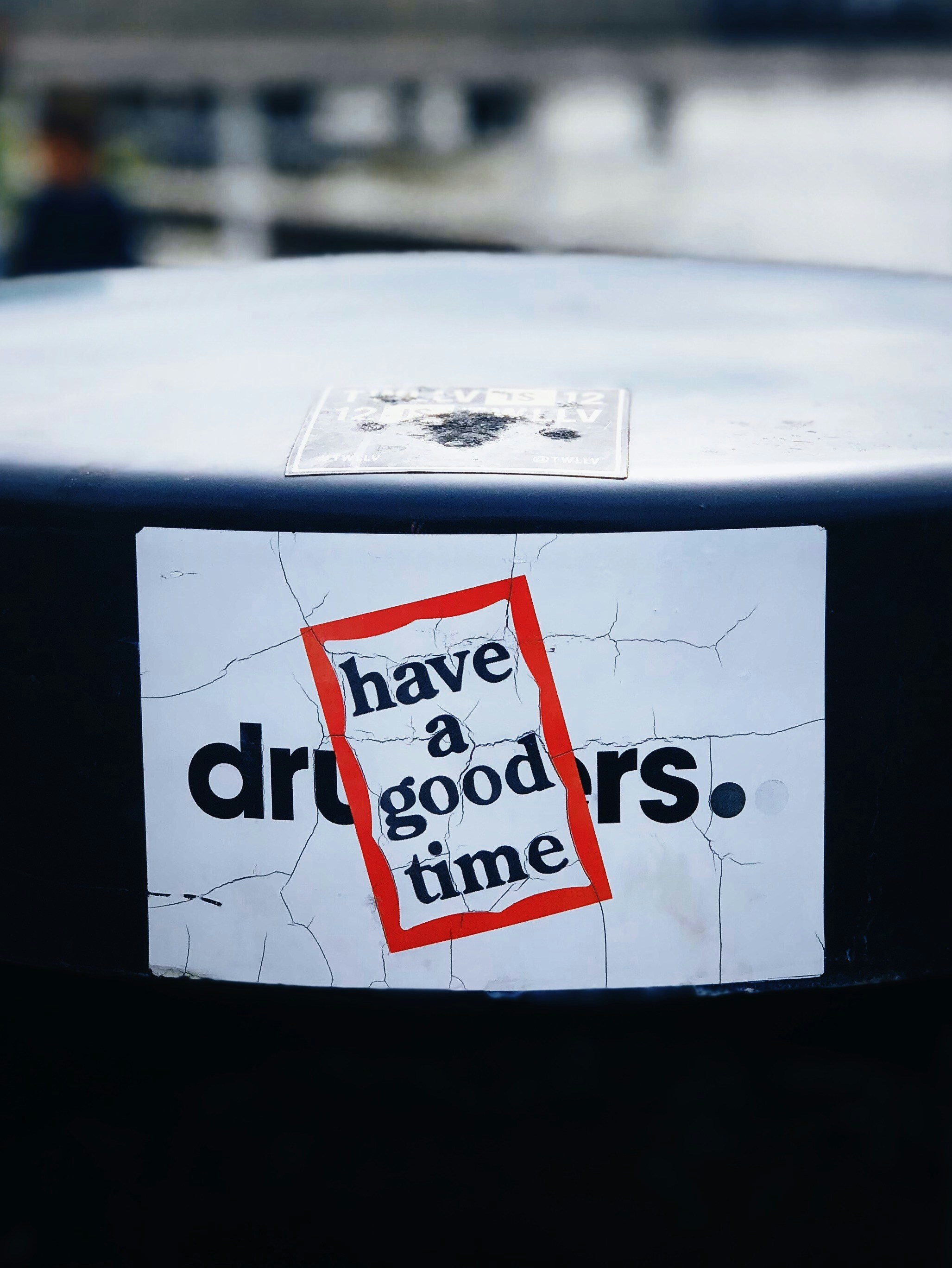 Have a Good Time: A pier-side sticker on a cracked white panel