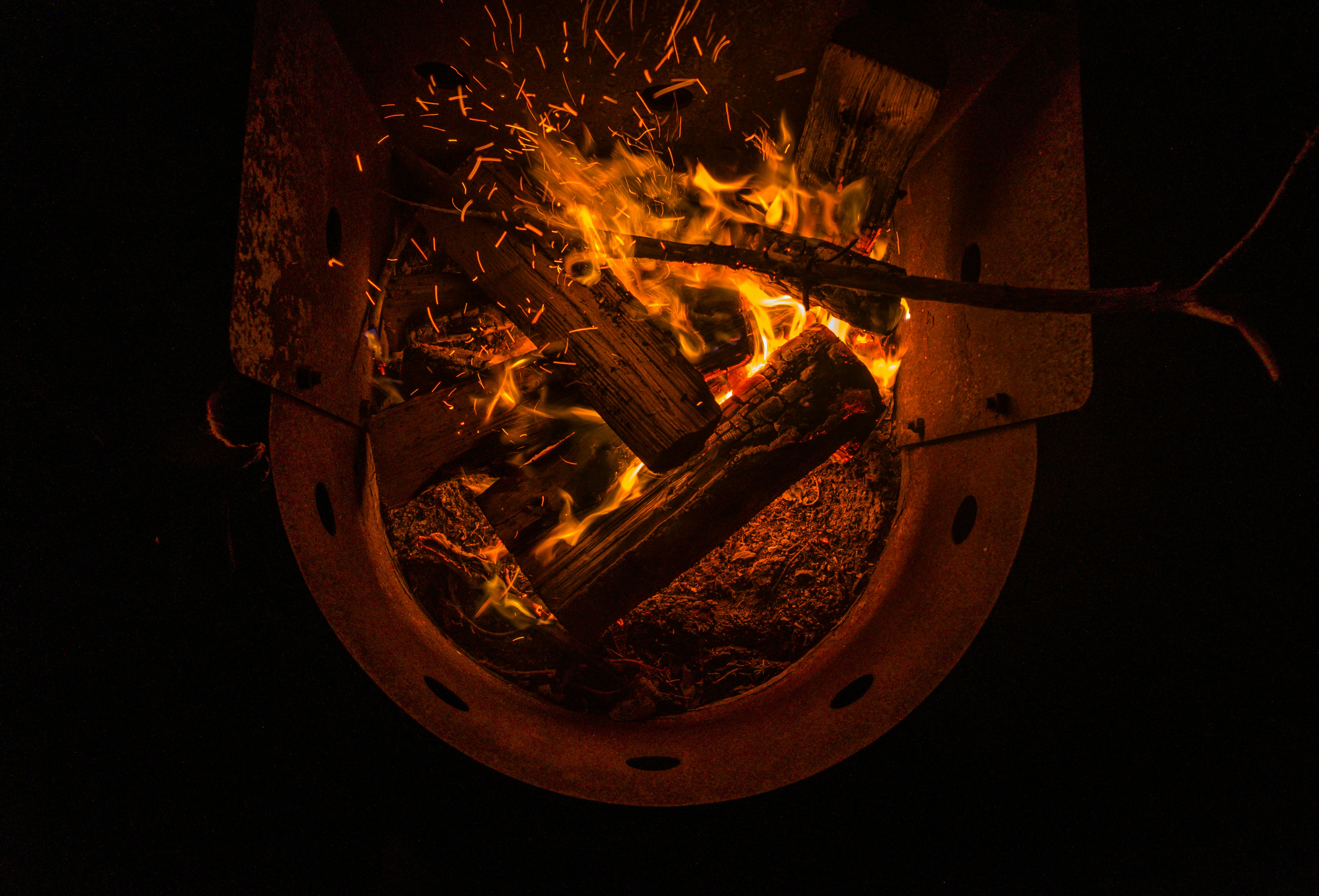 Ember Ring: glowing logs and sparks in a round fire pit