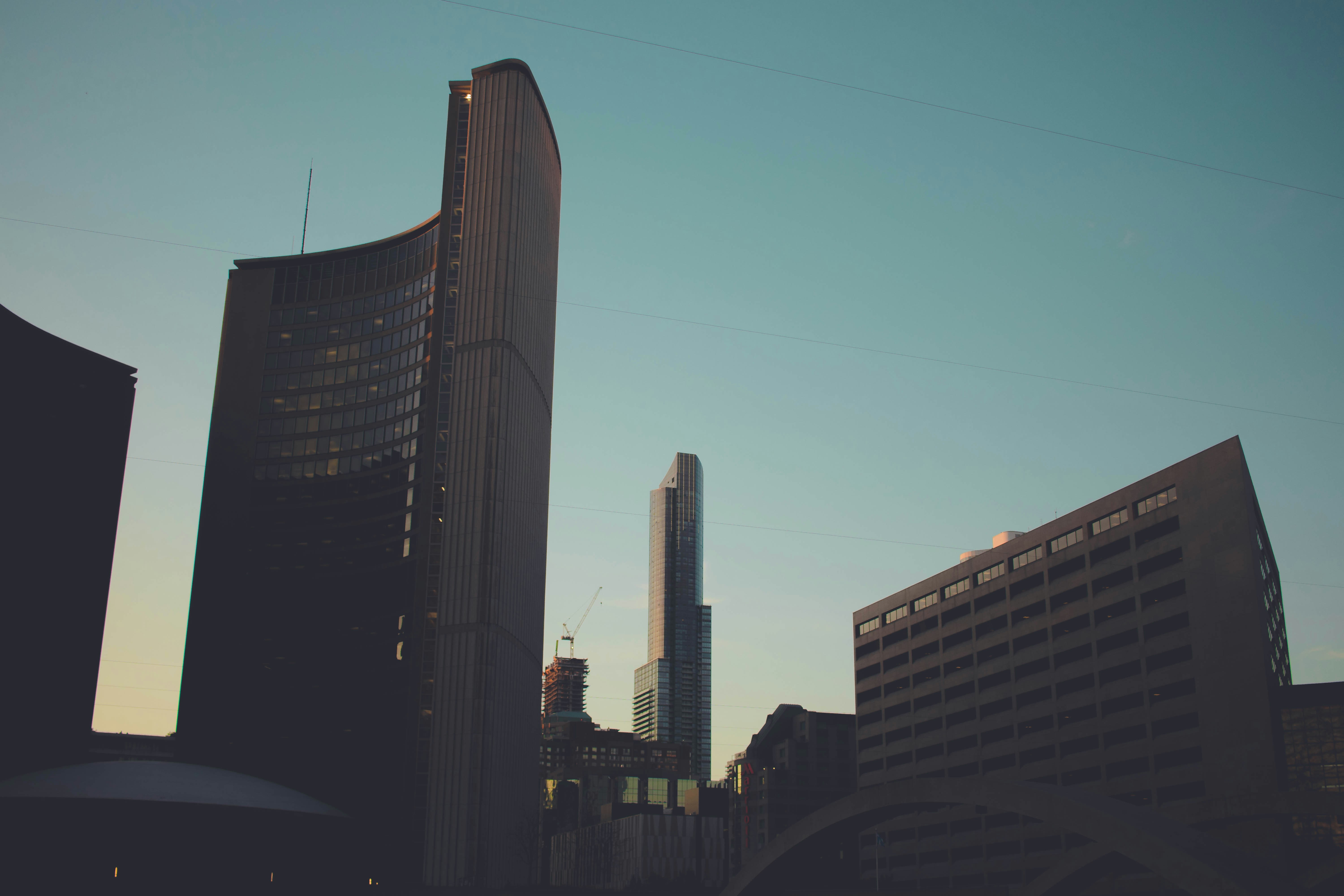 A skyline view featuring modern skyscrapers against a twilight sky, showcasing architectural diversity and urban life.