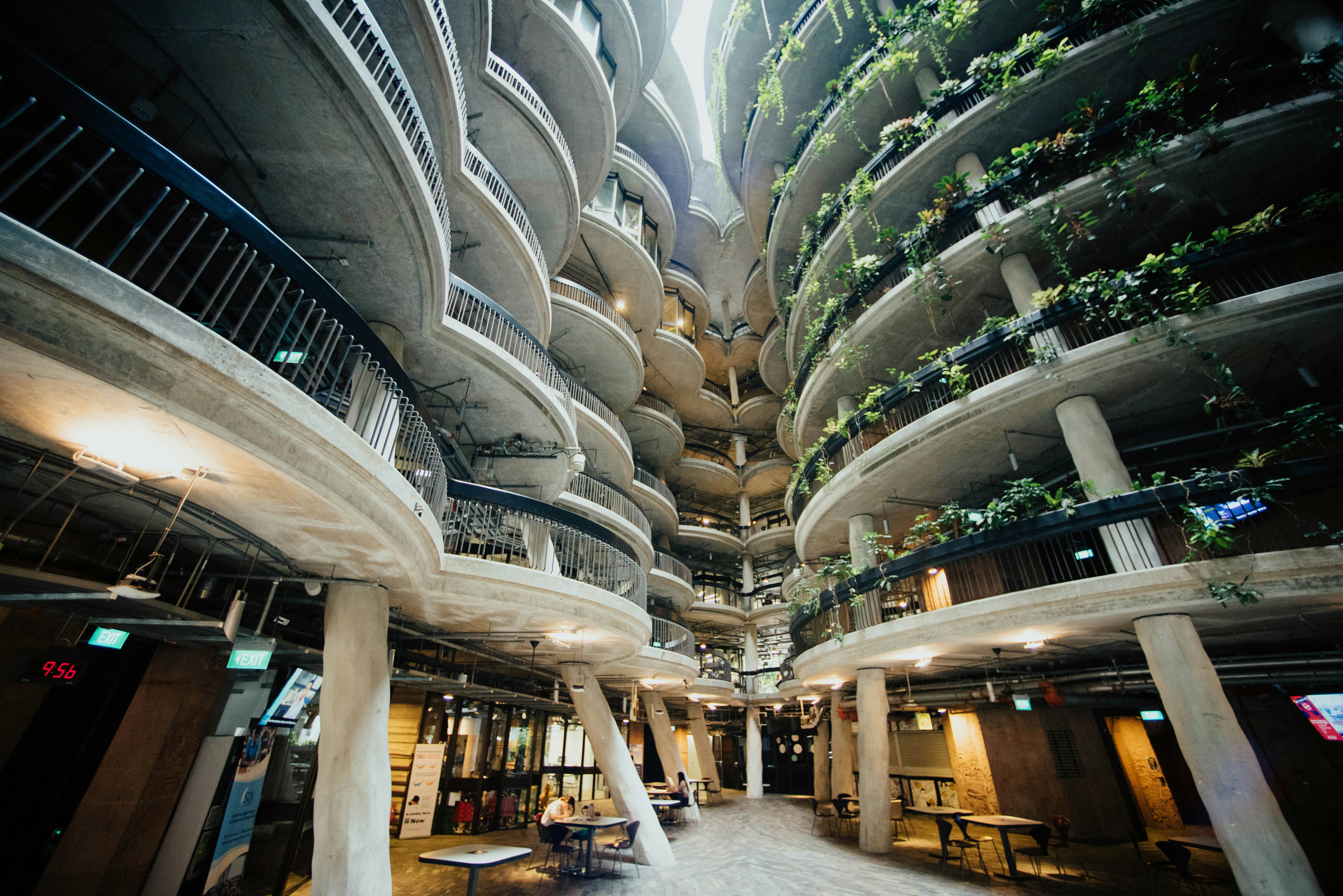 A Concrete Atrium in Bloom: Circular Balconies Framing Light