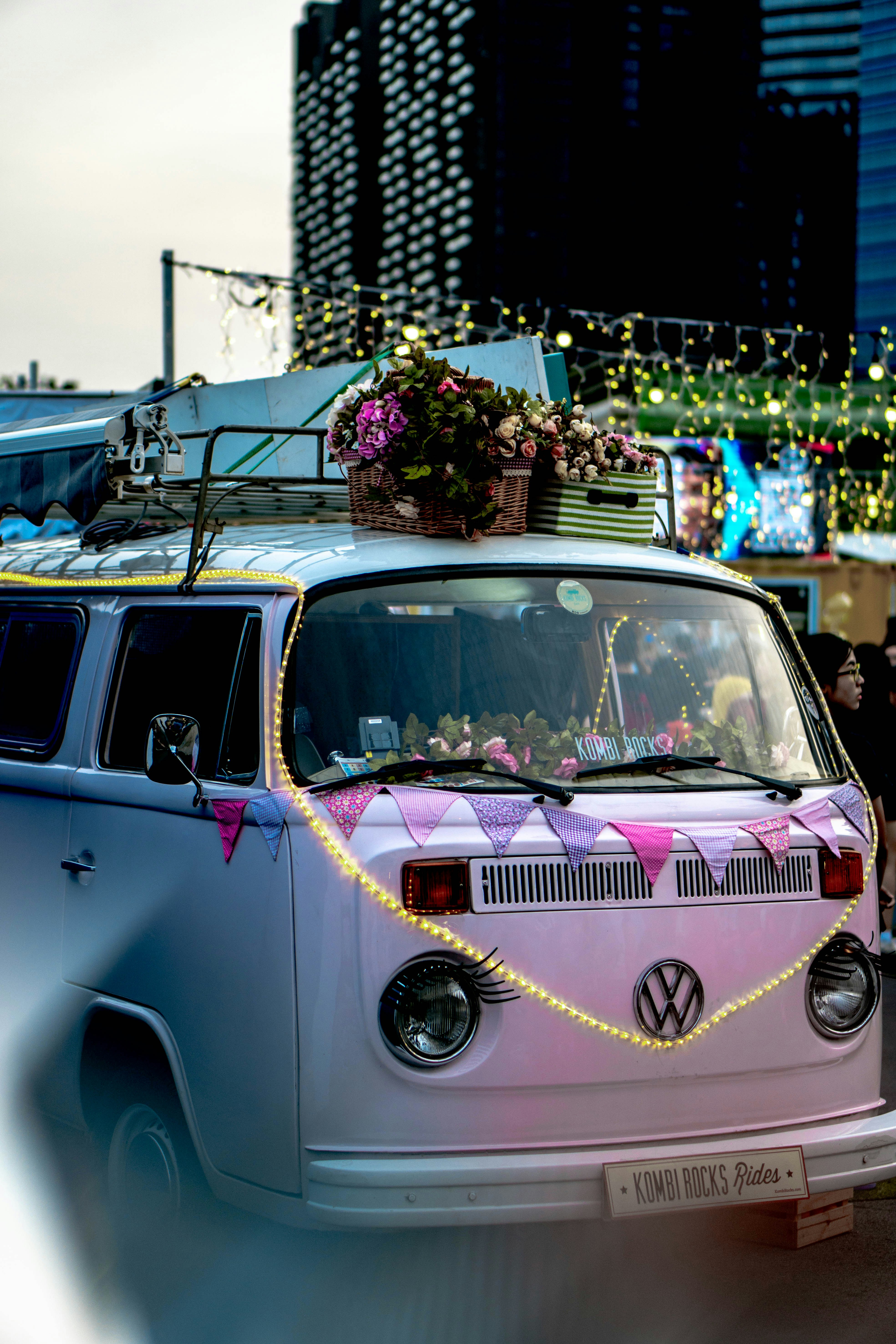 Flowered Rooftop VW Van Under City Night Lights
