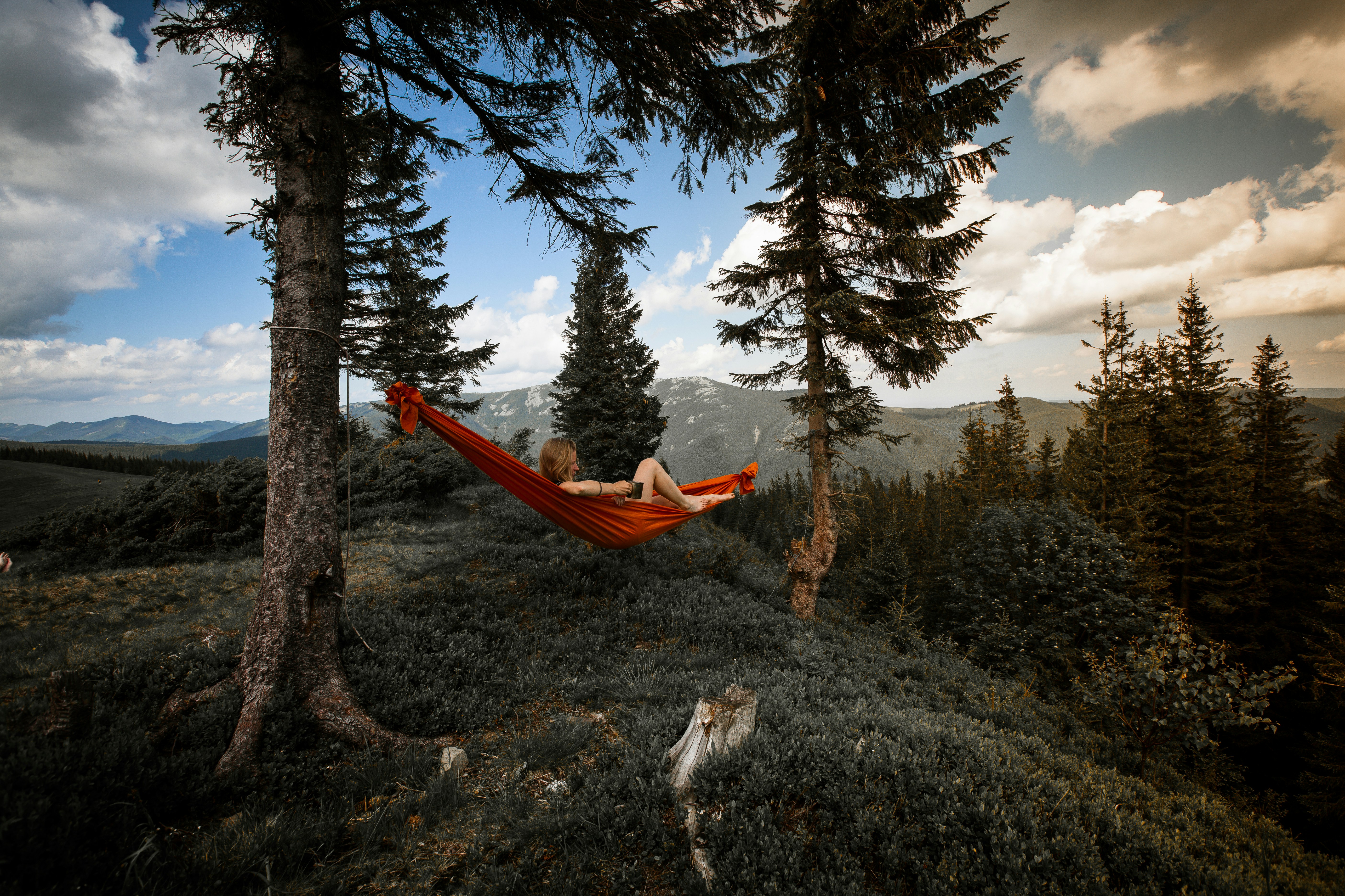 Our trip to the Carpatian Mountains | person lying on red hammock