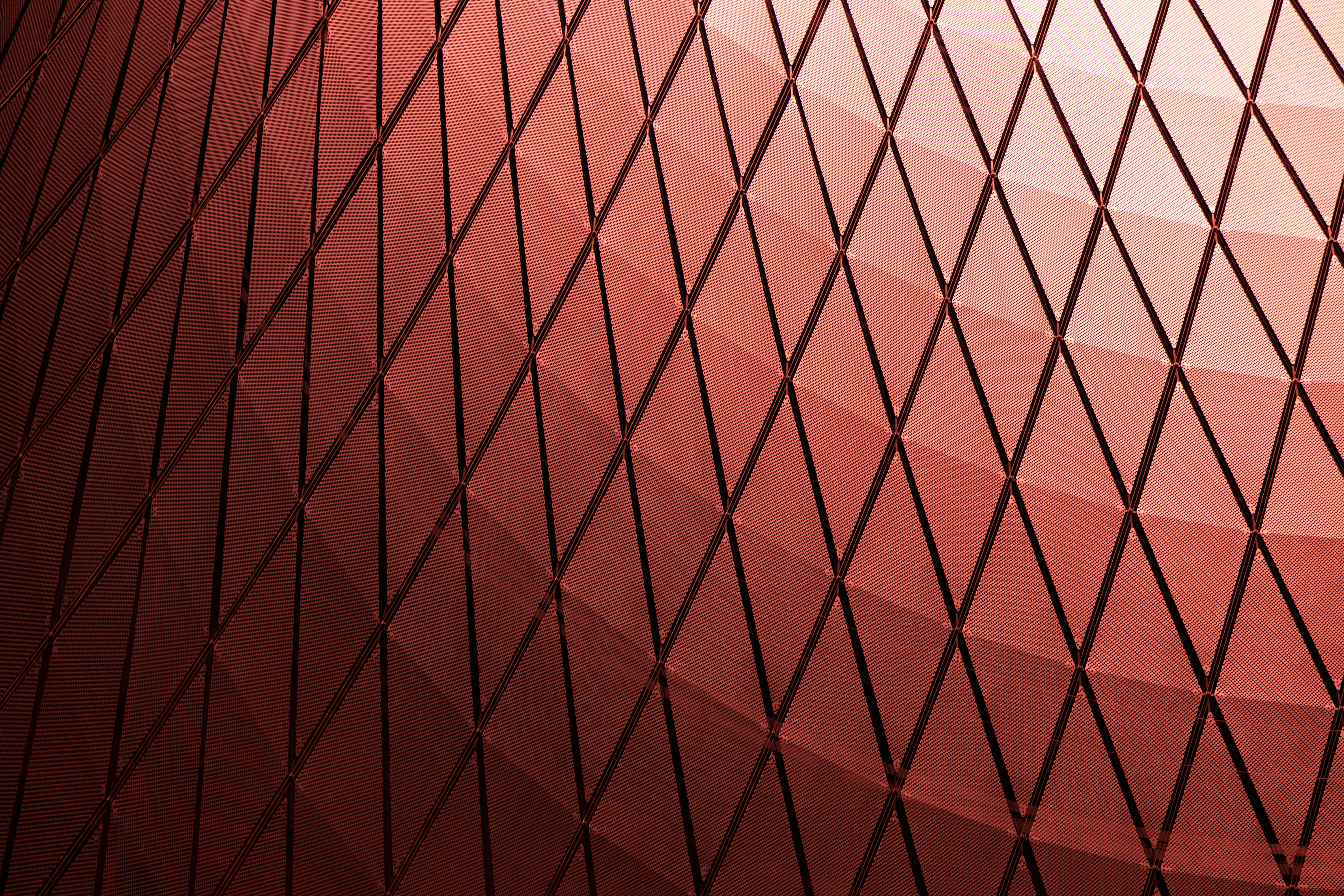 Close-up of a textured red facade featuring a diamond pattern, showcasing modern architectural design.
