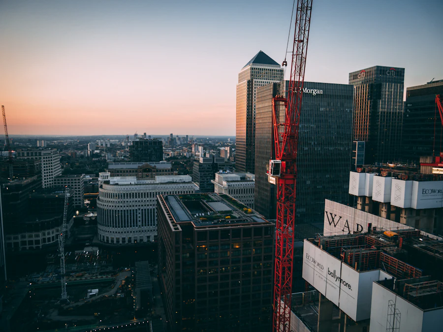Canary Wharf at sunset | red tower crane between buildings