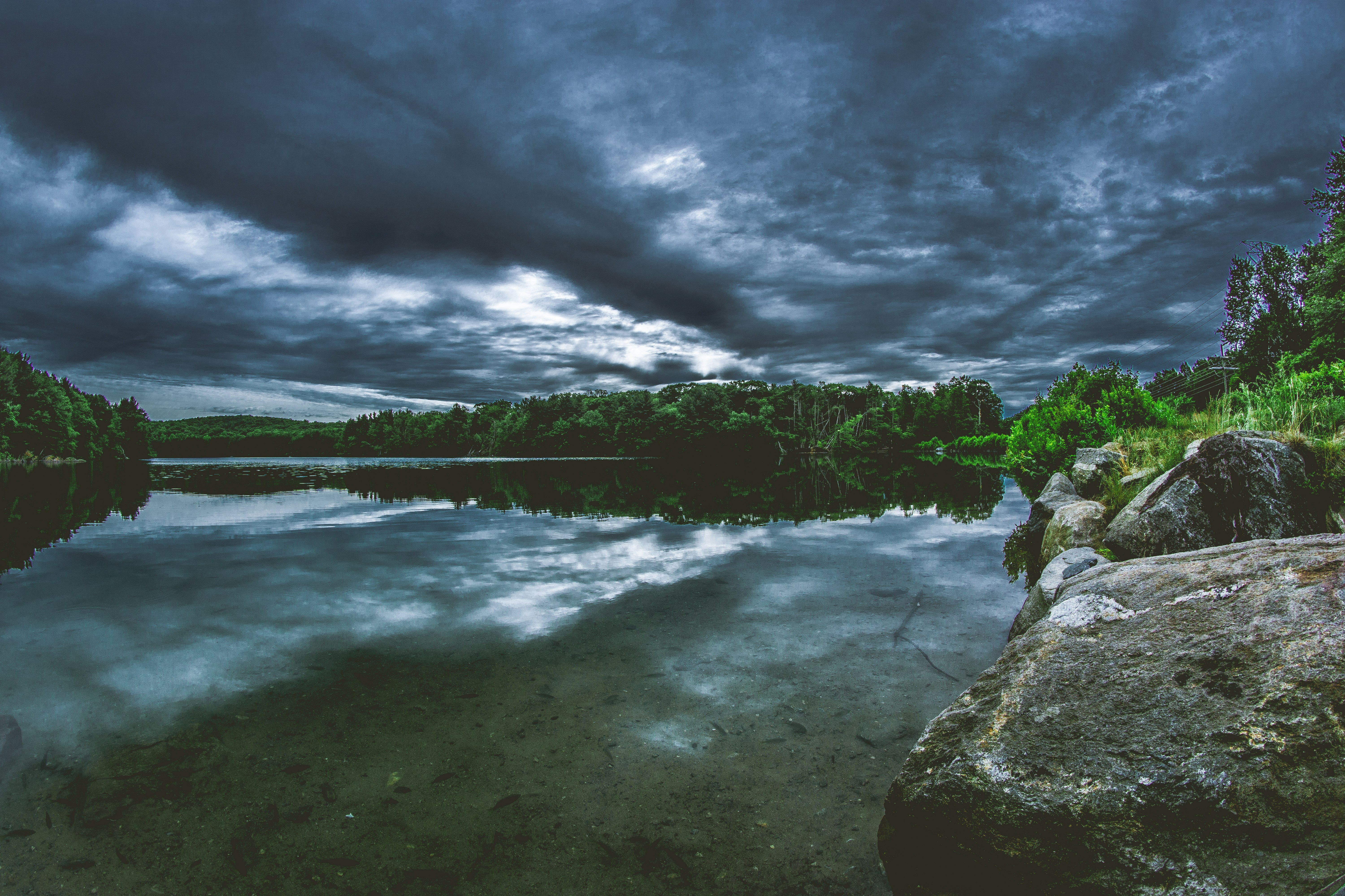 Morning hiking in Connecticut | body of water surrounded by trees under cloudy sky