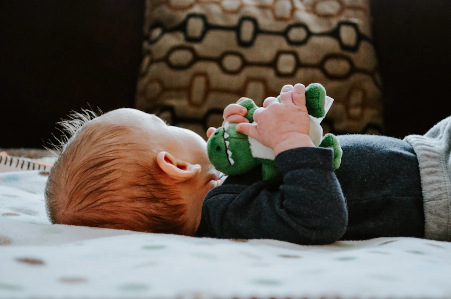 Our son’s very first miniature toy dinosaur ever. He fell in love with it, and has loved dinosaurs ever since. | baby lying on white bed