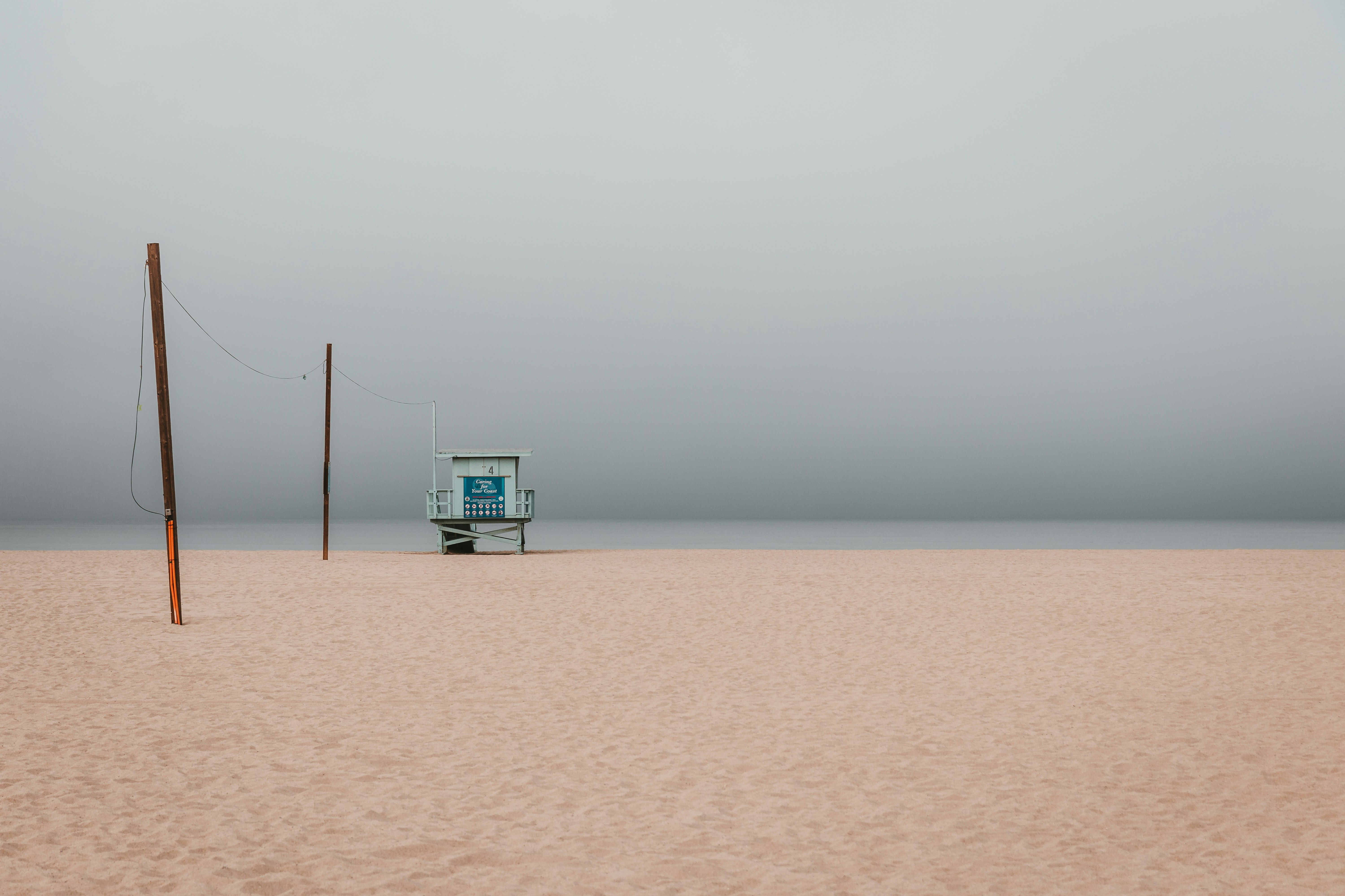 When I travelled to LA this summer, I was inspired by https://unsplash.com/@nate_dumlao ‘s picture  https://unsplash.com/photos/mhtEtB1hFSI. Although I hunted for 30 minutes to get the composition (and kept my family impatiently waiting), it was my first shot which I like the best. Thank you to https://unsplash.com/@anniespratt for her preset. | photo of volleyball net on sands