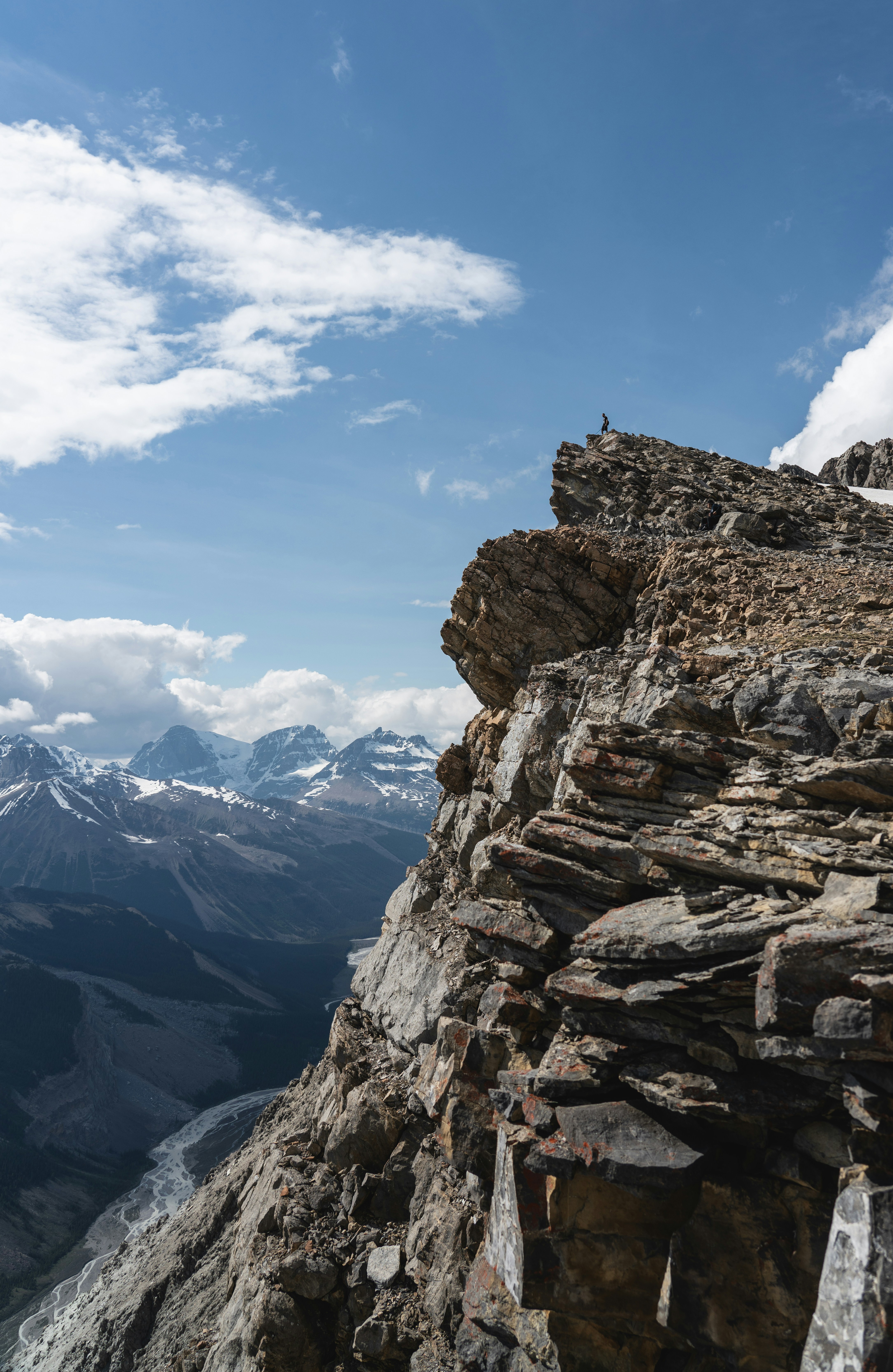 A Lone Climber Guards the Summit from A Jagged Overhang