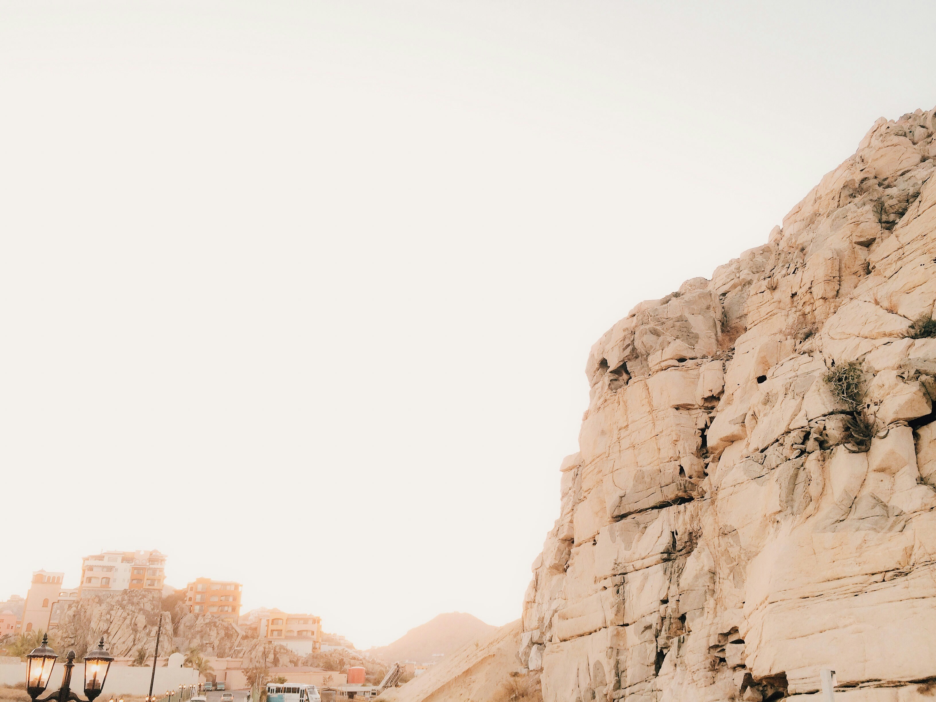 Ridge of Quiet Scale: Rock Face Framing a Distant Town