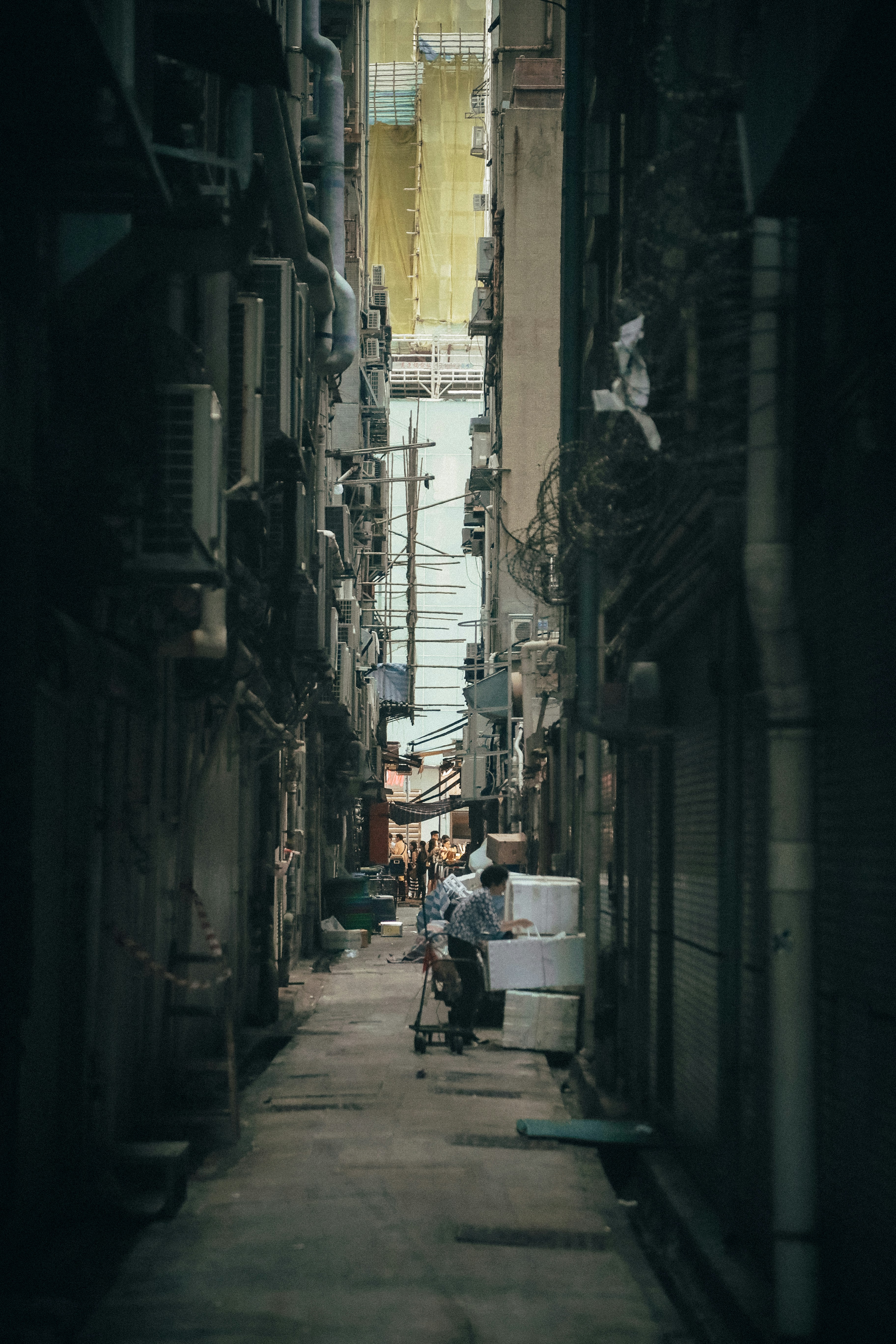 Person sitting on chair between building at daytime photo – Free Street ...