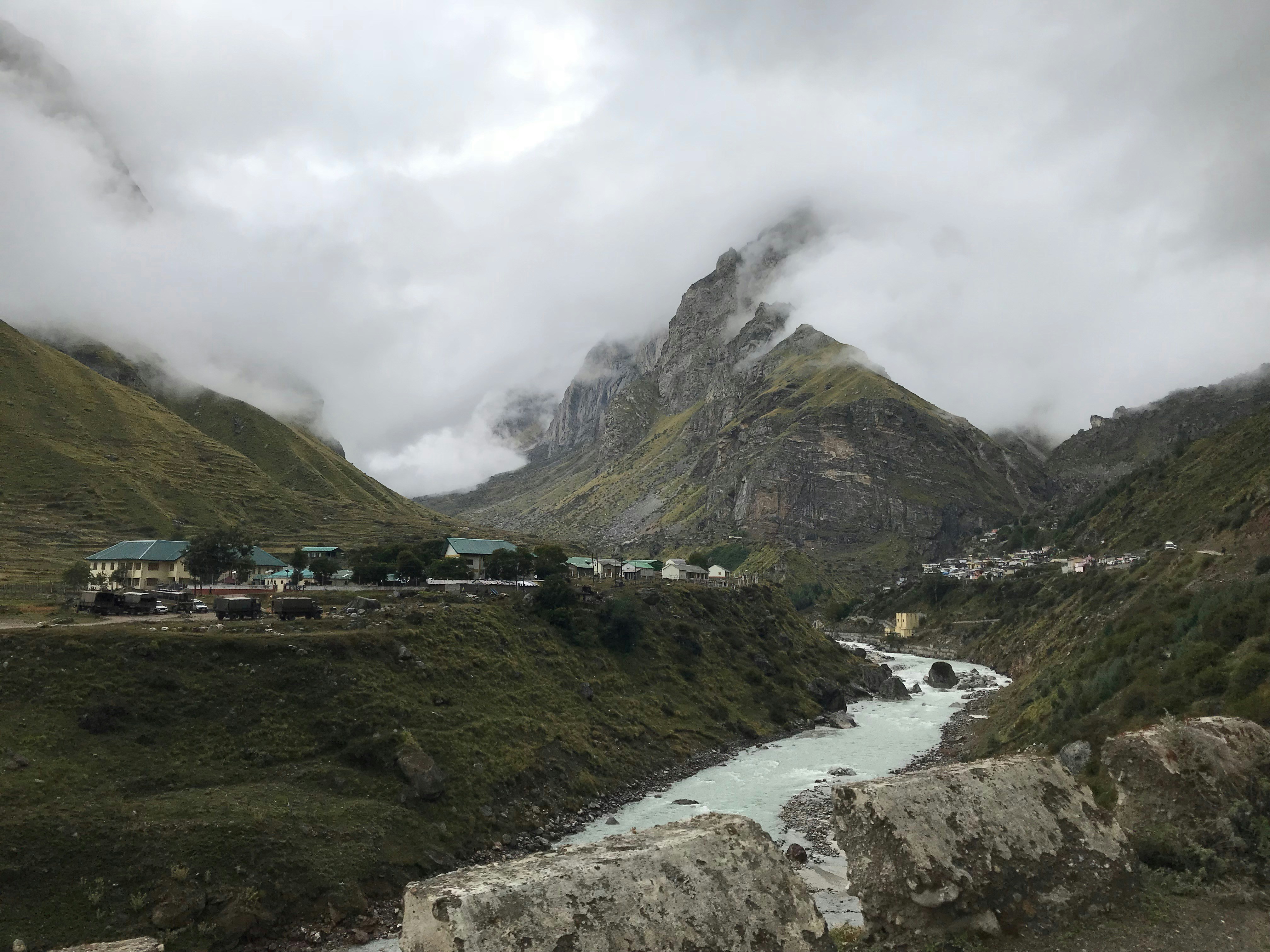 Mist-Wrapped Summit Over a Turquoise Mountain River Valley