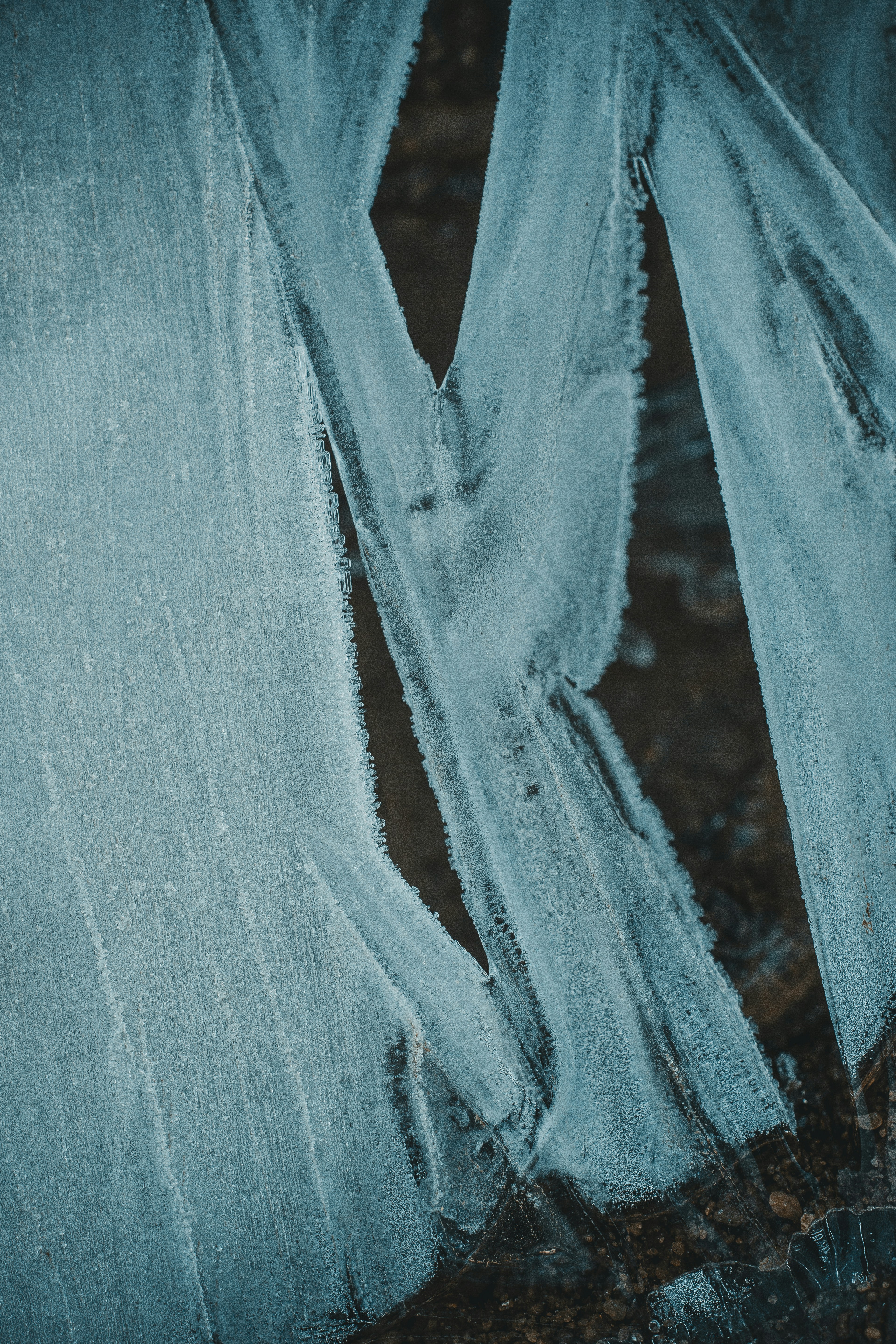 Blue Frost Facets: Close-Up of Ice Crystals in a Dark Grotto