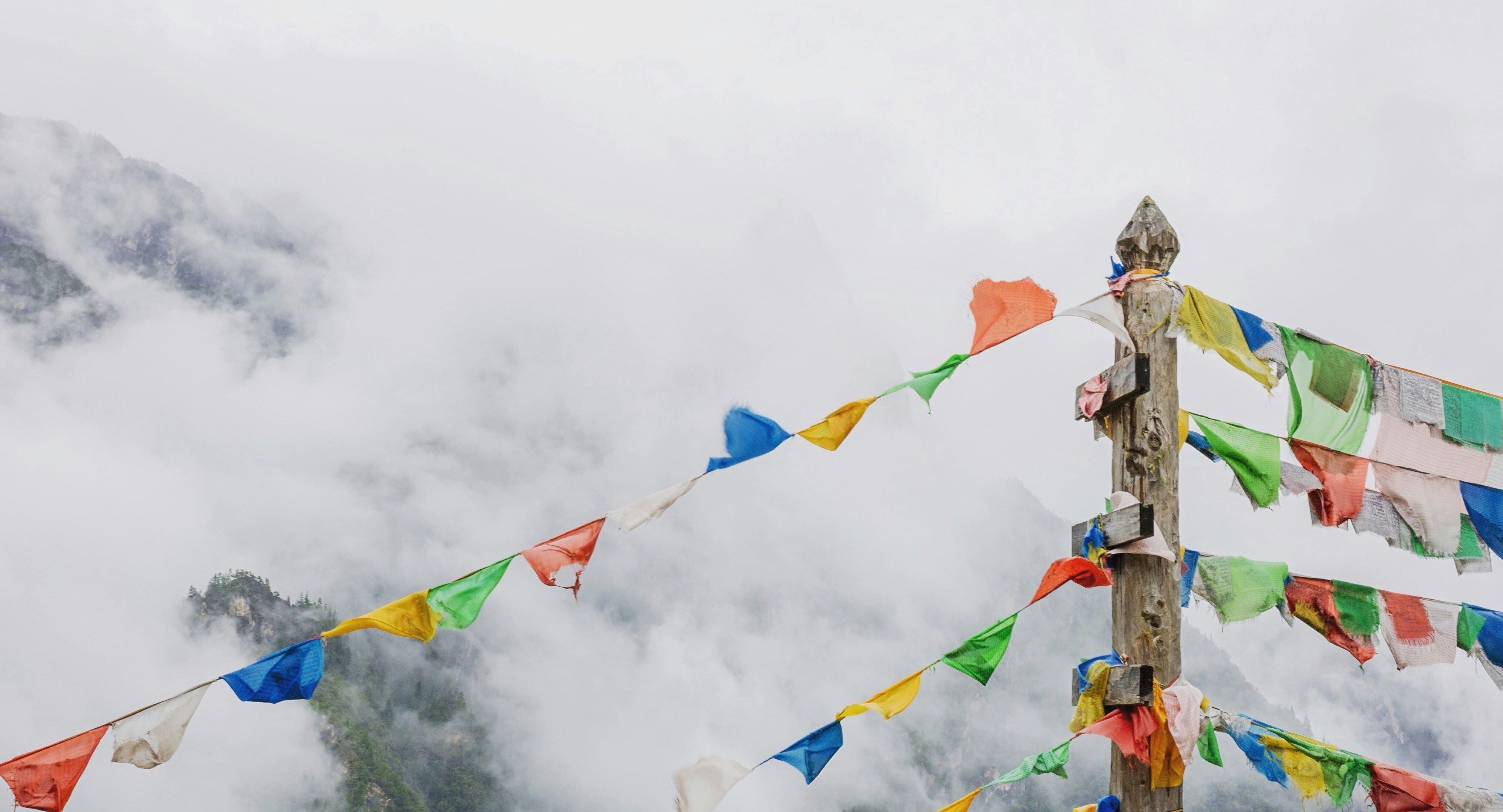Pole with flaglets under white clouds photo – Free China Image on Unsplash
