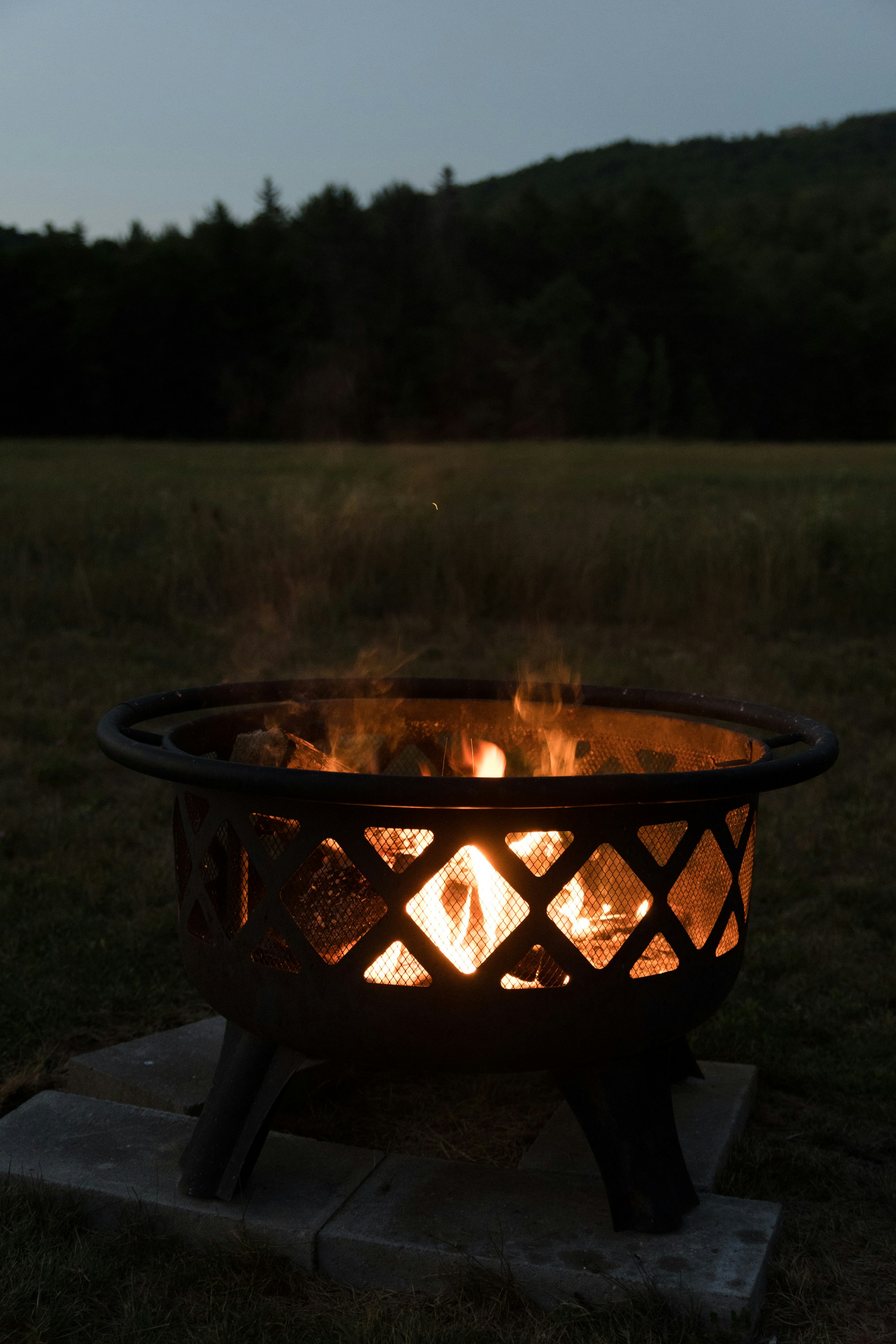 Ember Ring: Fire Pit Glow Against Dusk Meadow