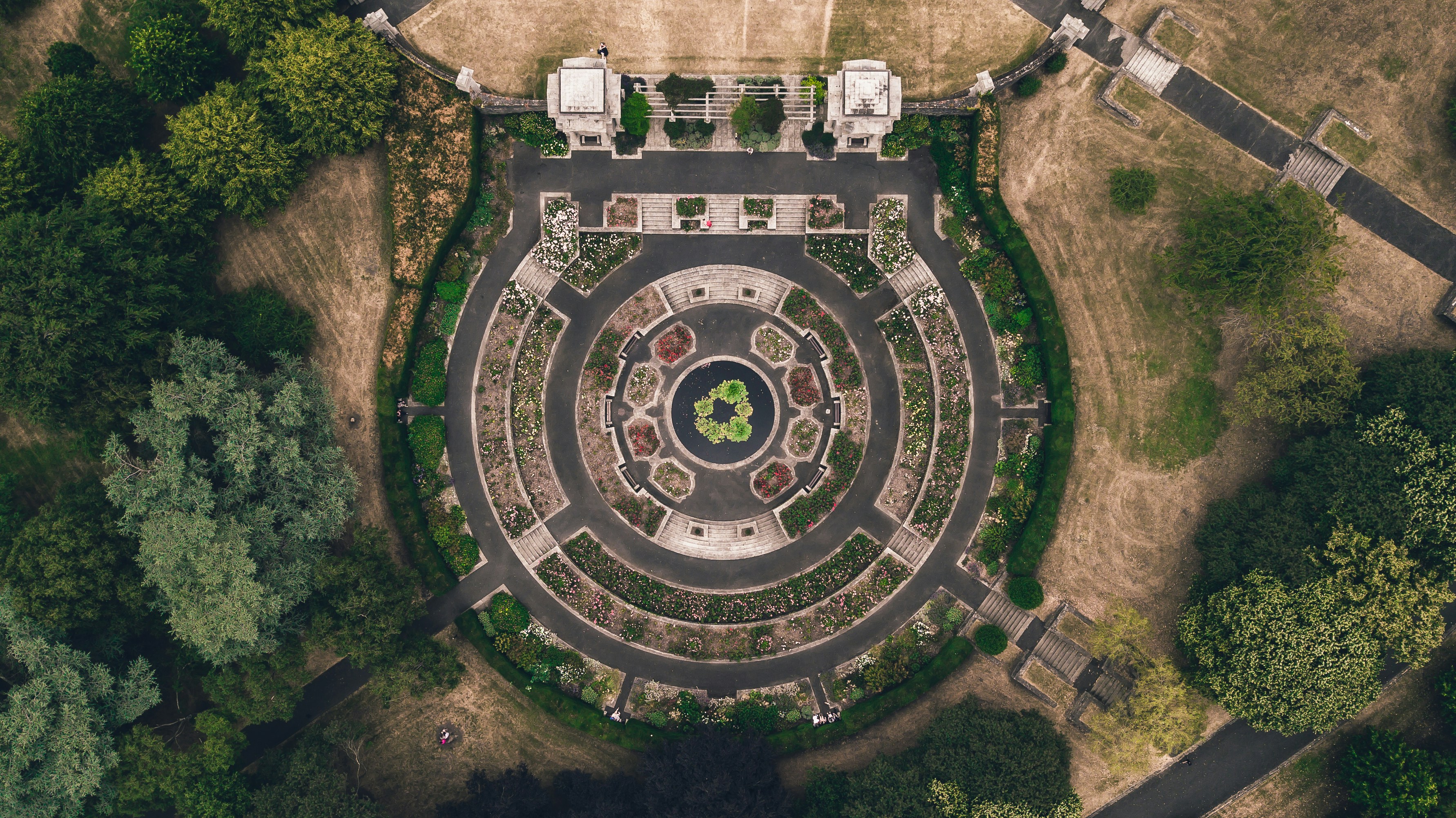 Intricate circular garden design surrounded by lush greenery.