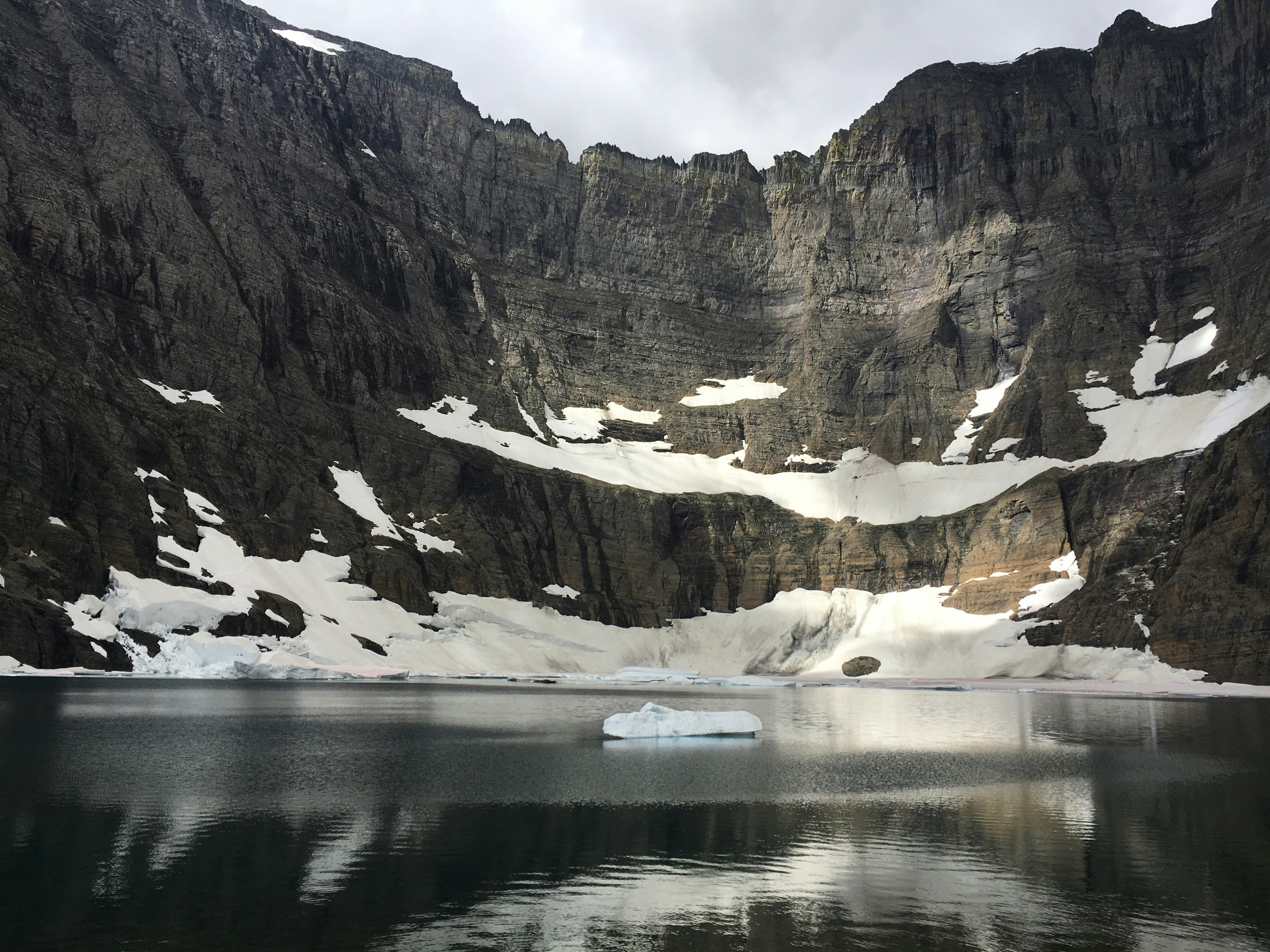 Icebound Amphitheater: A Silent Lake Nestled Under Cliff Walls