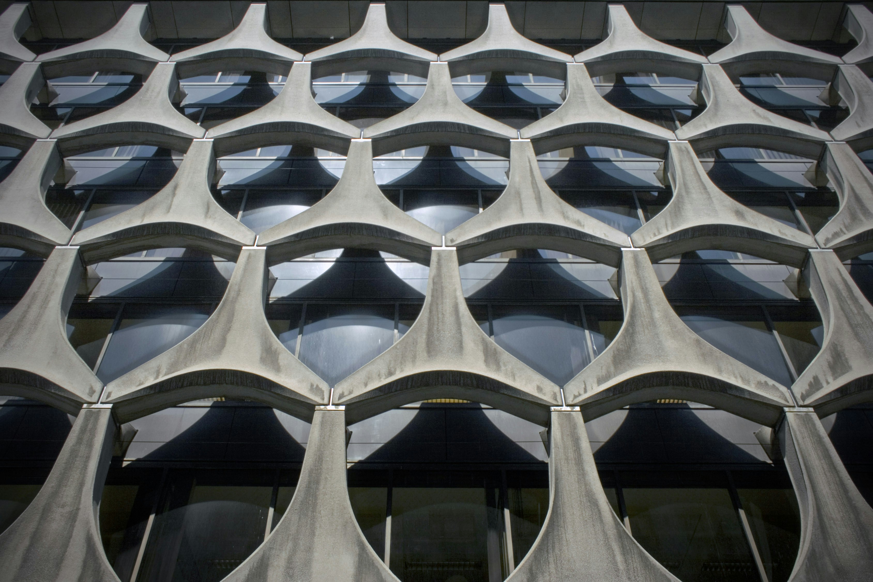 Repetitive hexagonal patterns on a building facade create a rhythmic architectural design.