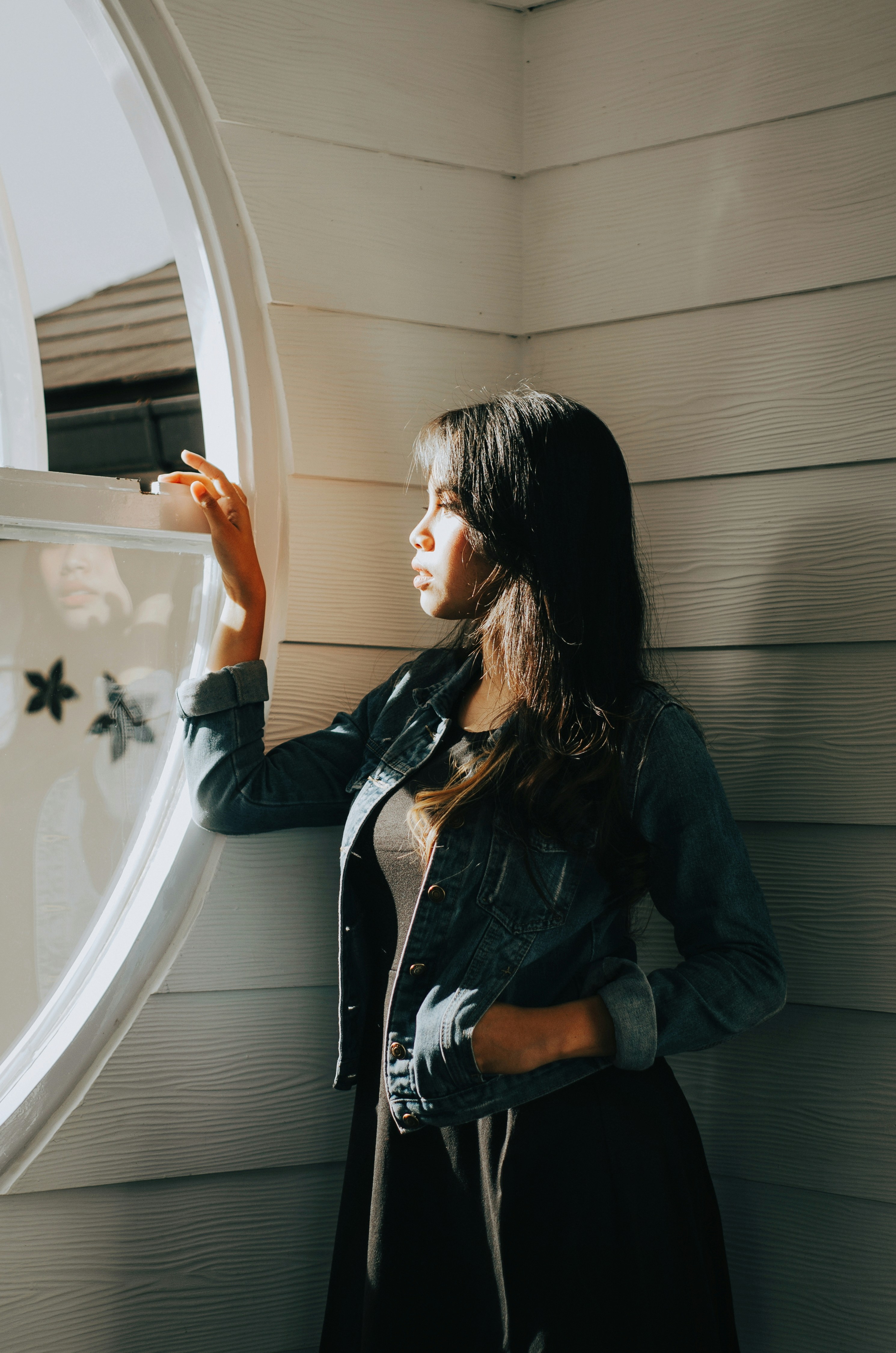 Woman in blue denim jacket standing beside window photo – Free Bandung ...