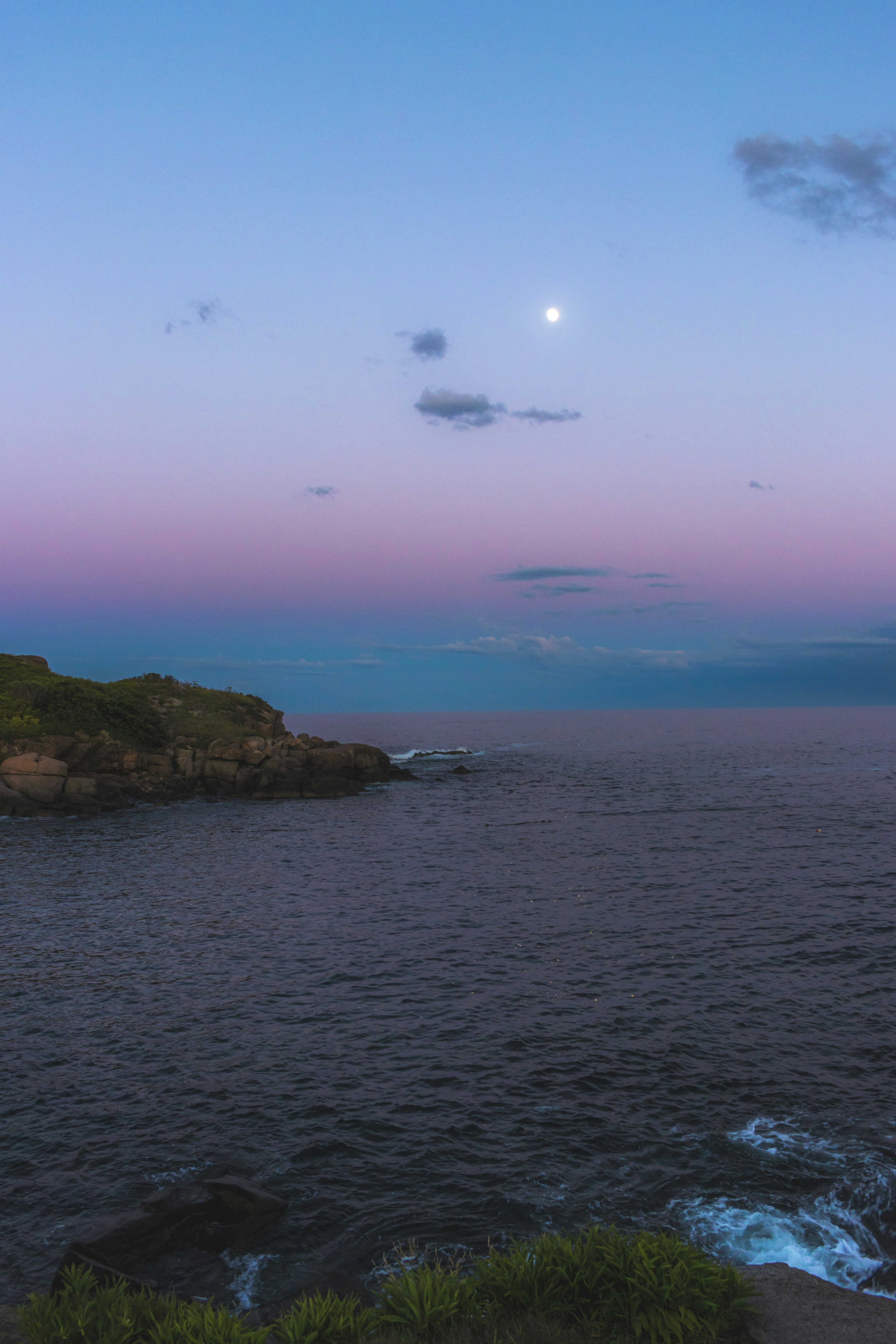 Moonlit Horizon: Twilight Seascape from a Coastal Clifftop