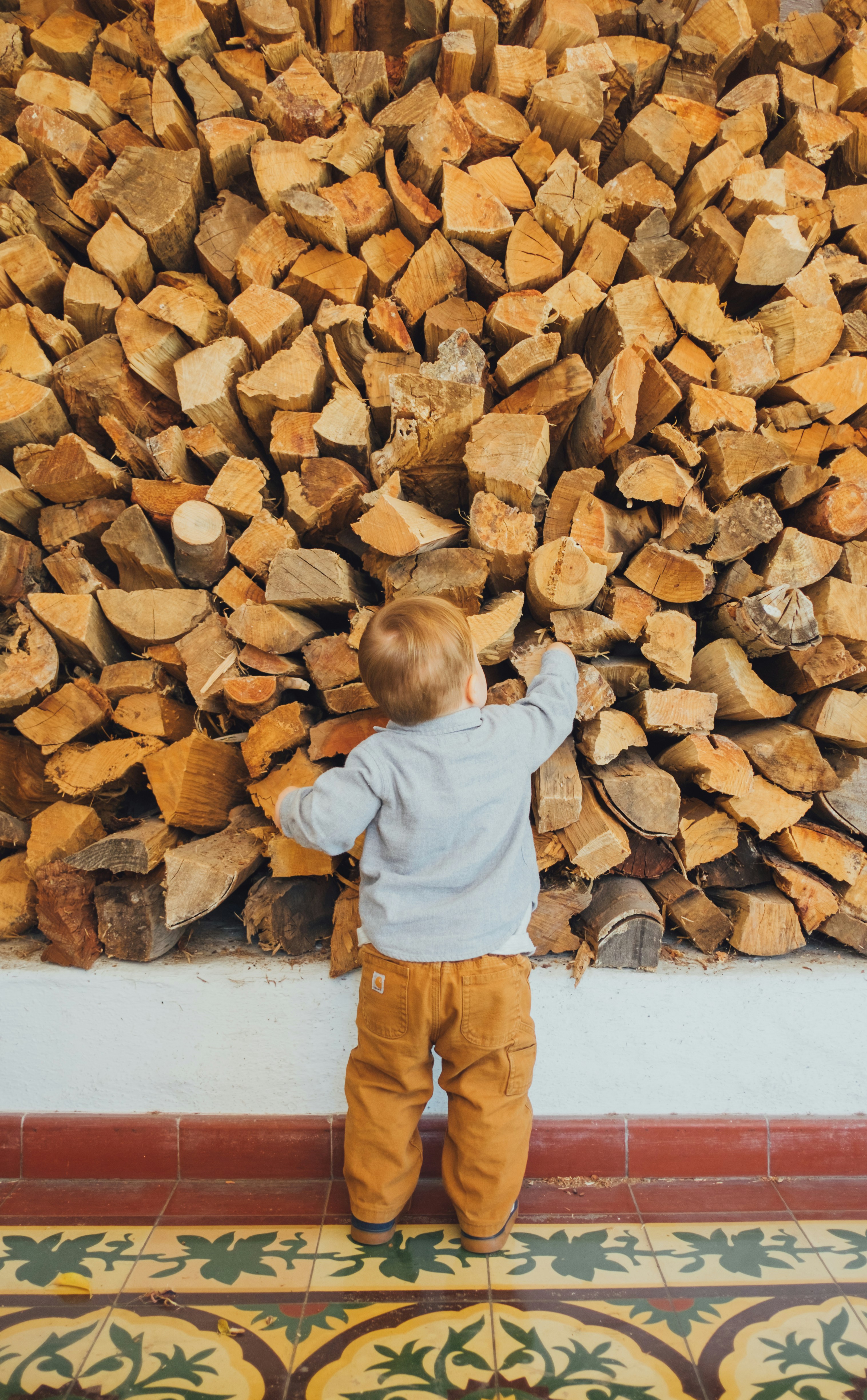 They have an amazing outdoor fireplace at the Casa Romantica in San Clemente — my son was intrigued by the giant woodpile, and I loved the way his clothes lined up and contrasted with the wood and plaster.