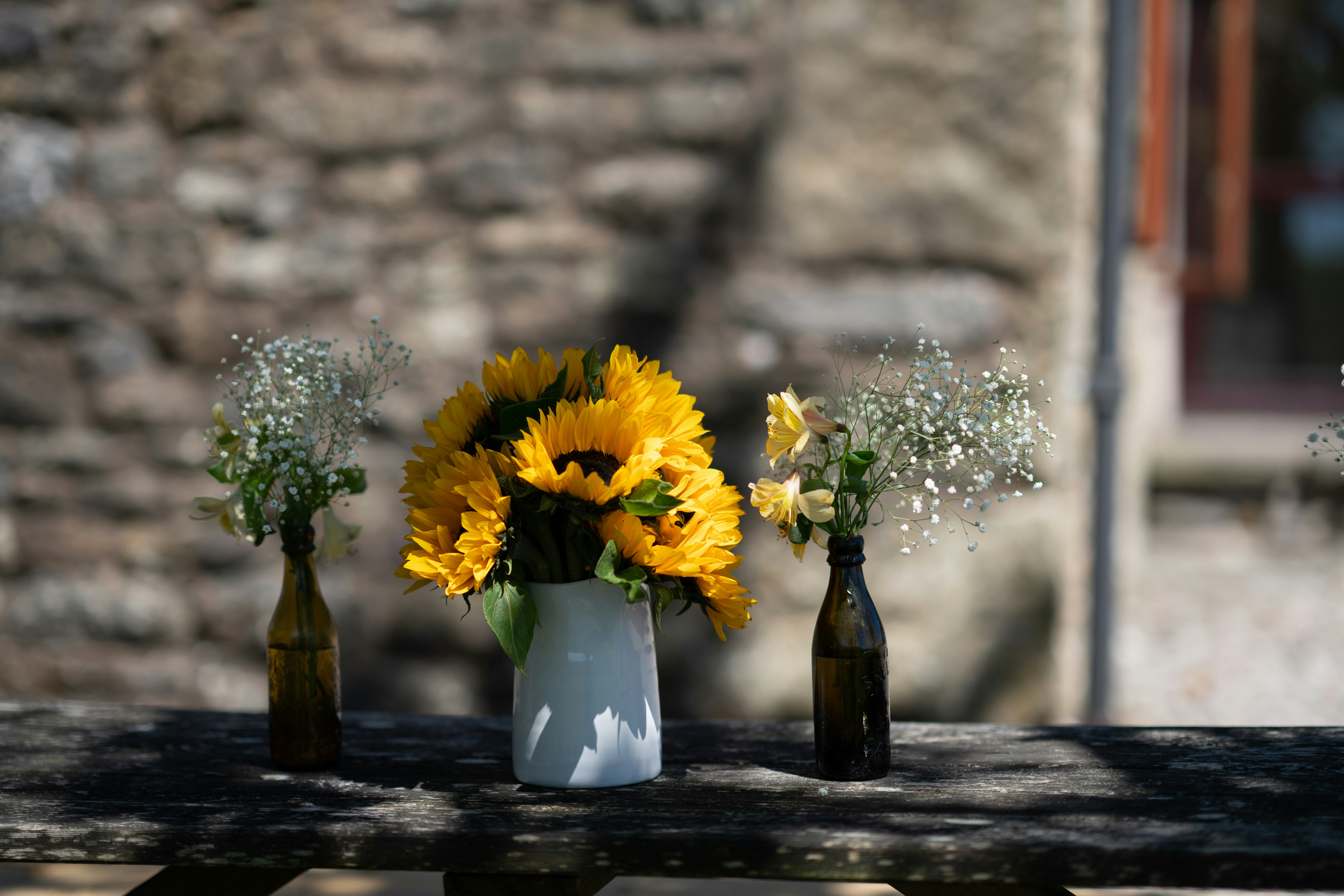 Sunflowers in a Weathered Still Life by the Stone Wall
