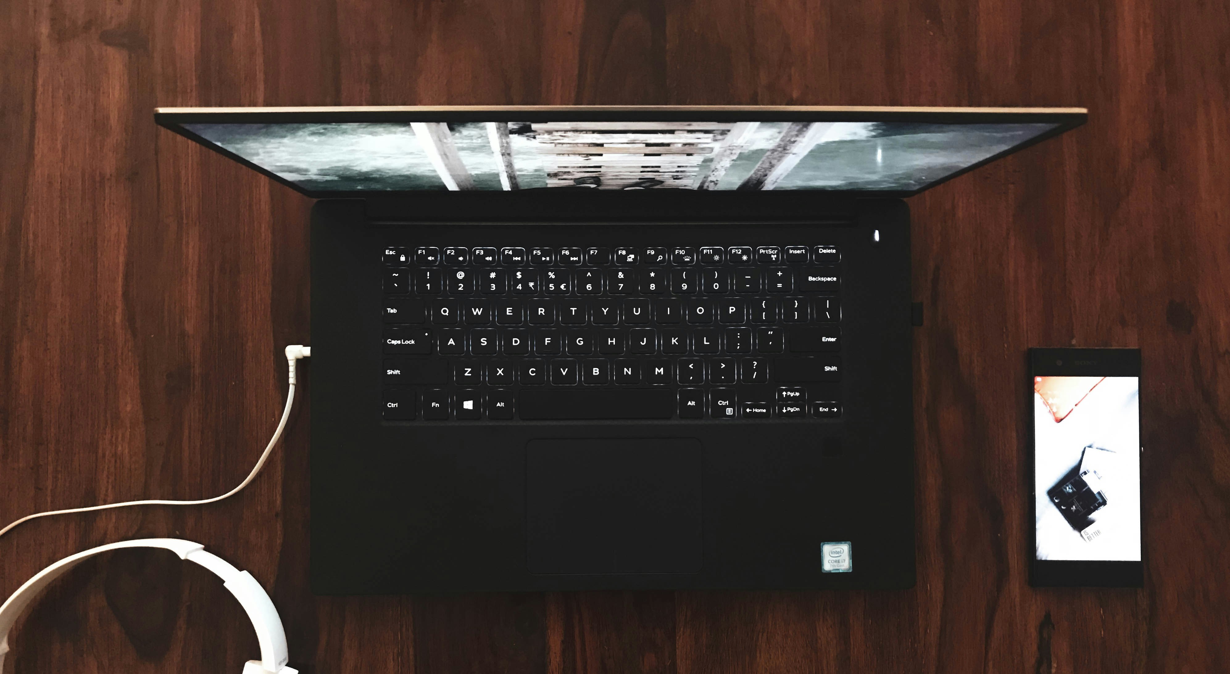 Black and gray laptop computer turned on on wooden surface photo – Free ...