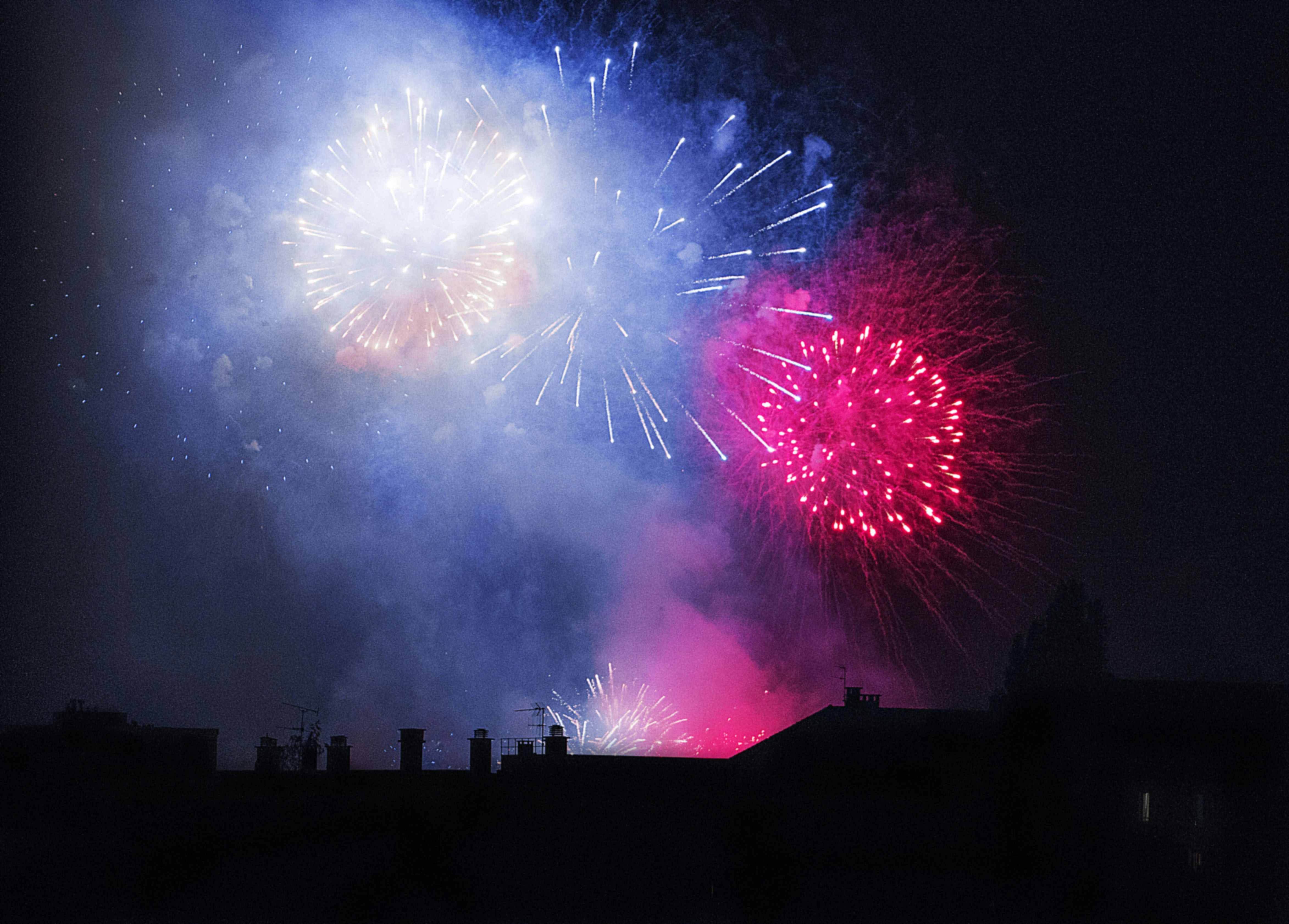 Vibrant Pyrotechnic Symphony Over City Silhouettes