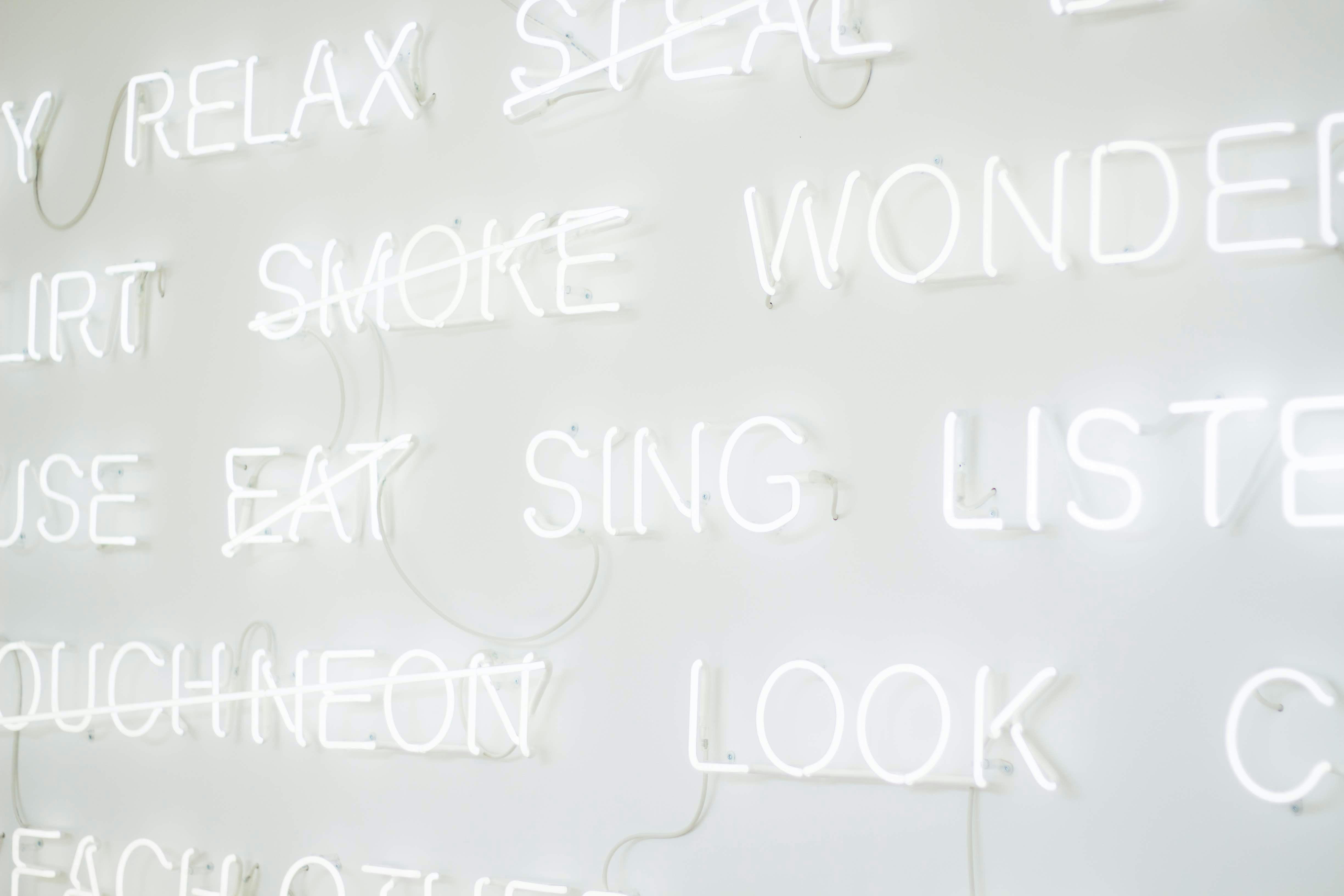 A white sign with words written on it photo – Free Grey Image on Unsplash