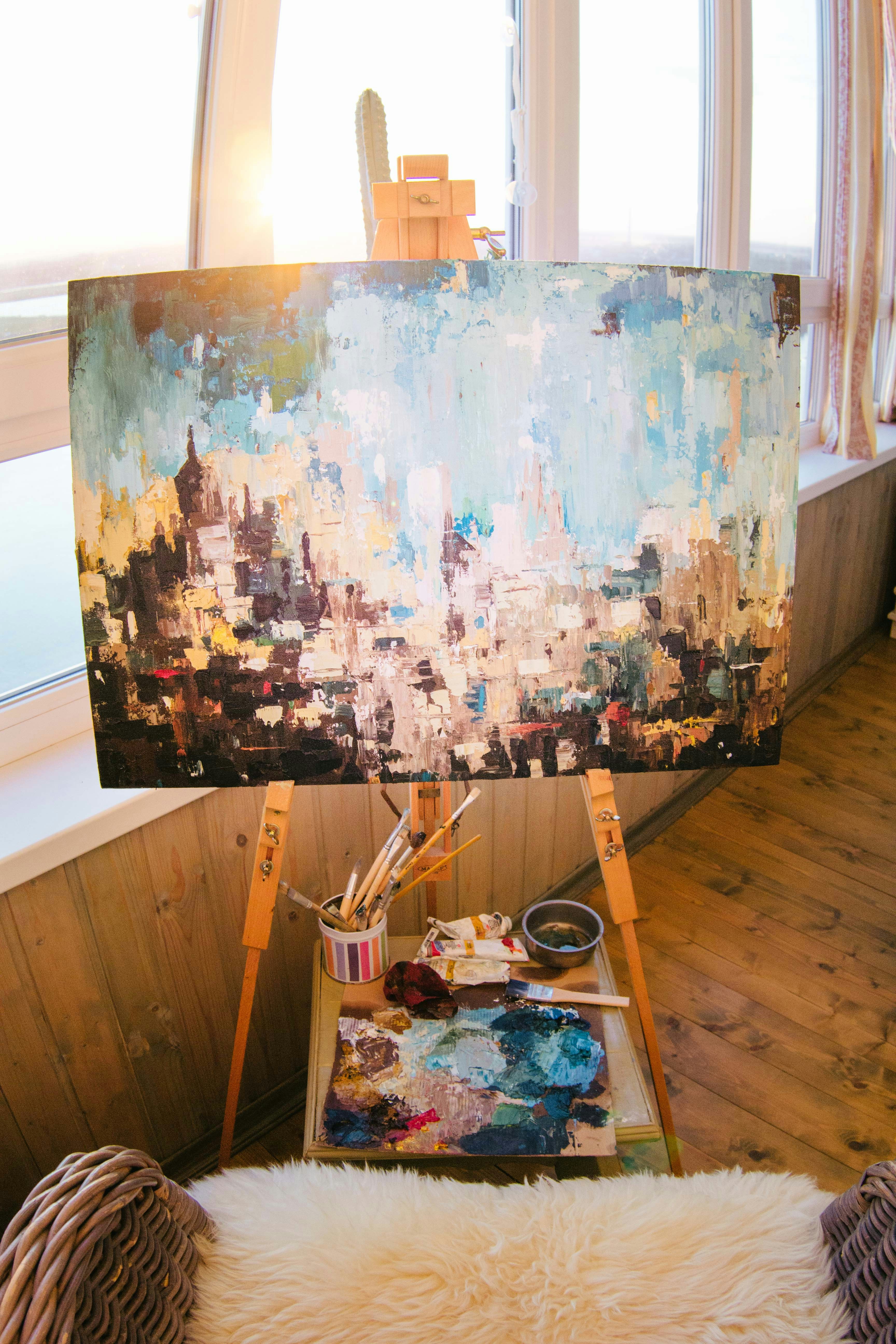 Sunlit City Fragments: An Abstract Cityscape on a Studio Easel