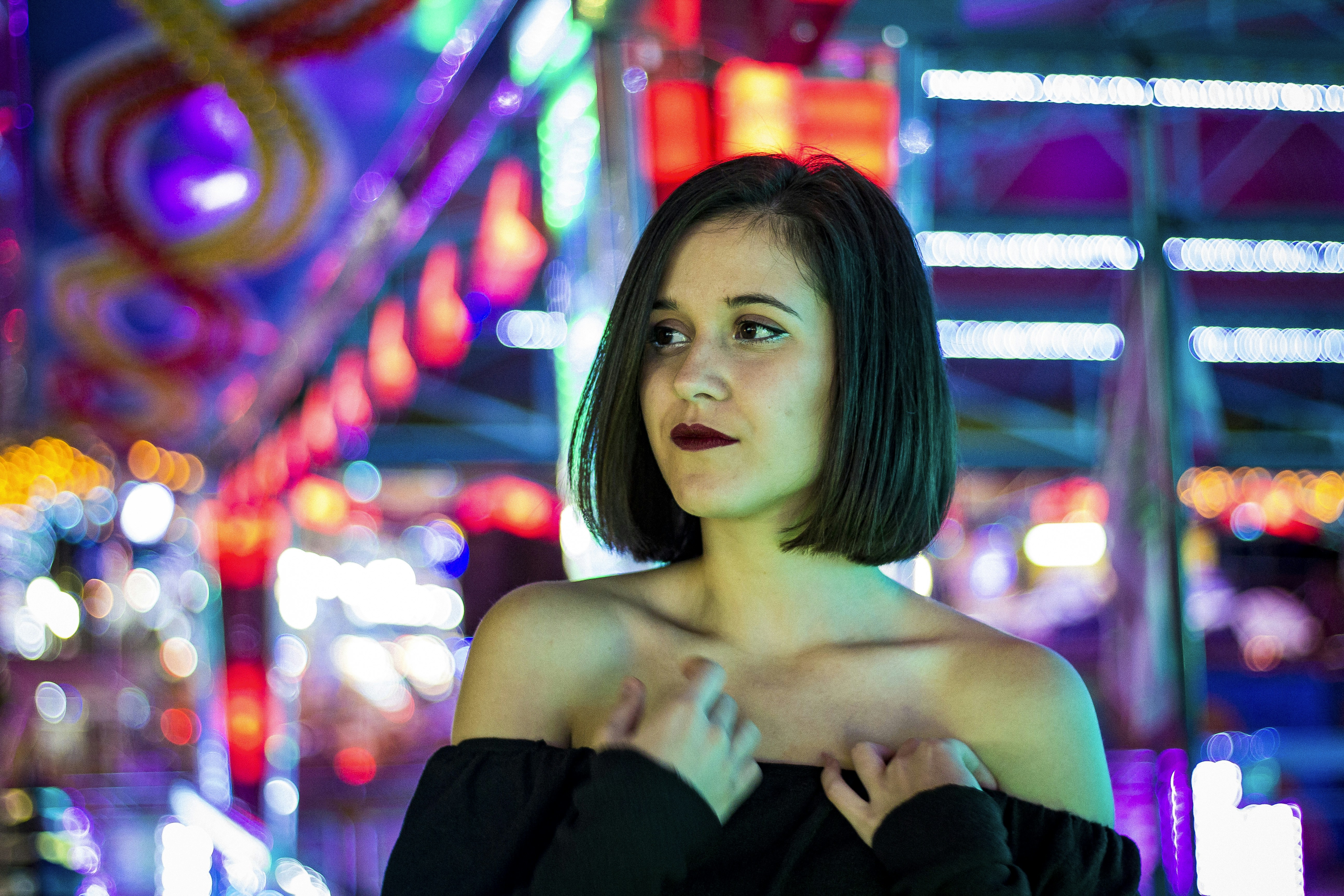 Neon Velvet: A Quiet Portrait Beneath Carnival Lights