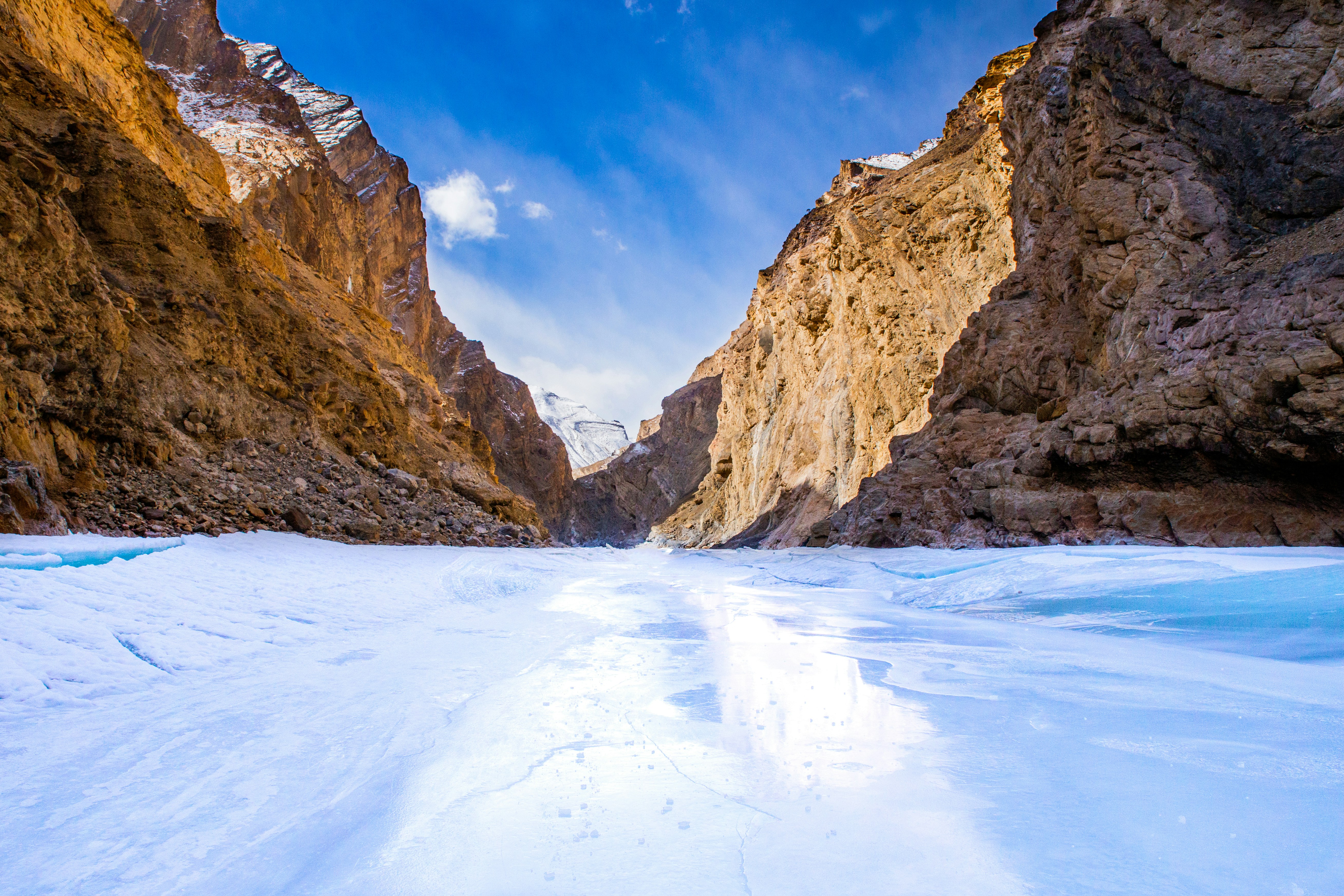 Icebound Vantage: Snowfield Leading Toward a Sky-Blue Canyon