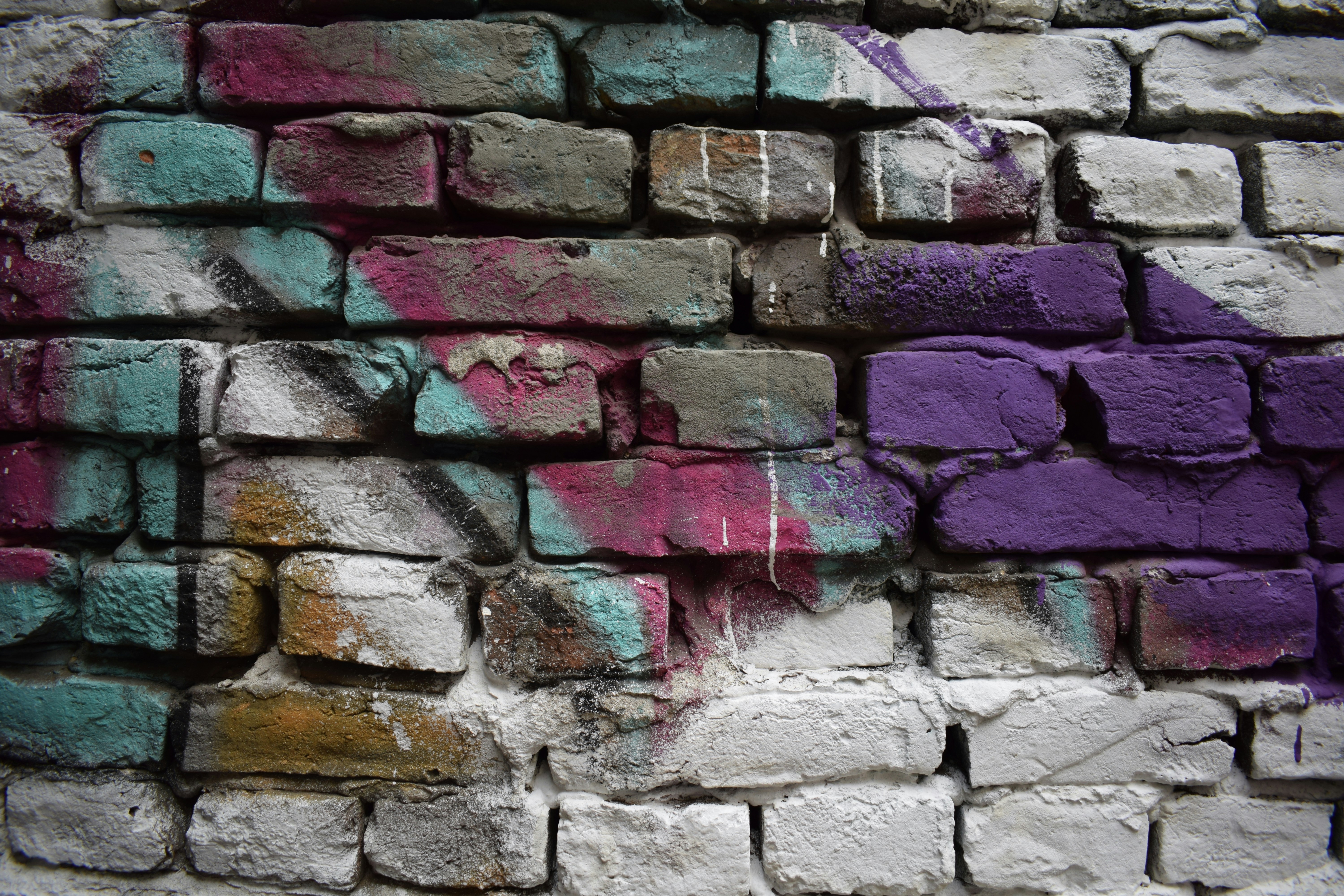 Graffiti with vibrant colors on a textured brick wall.