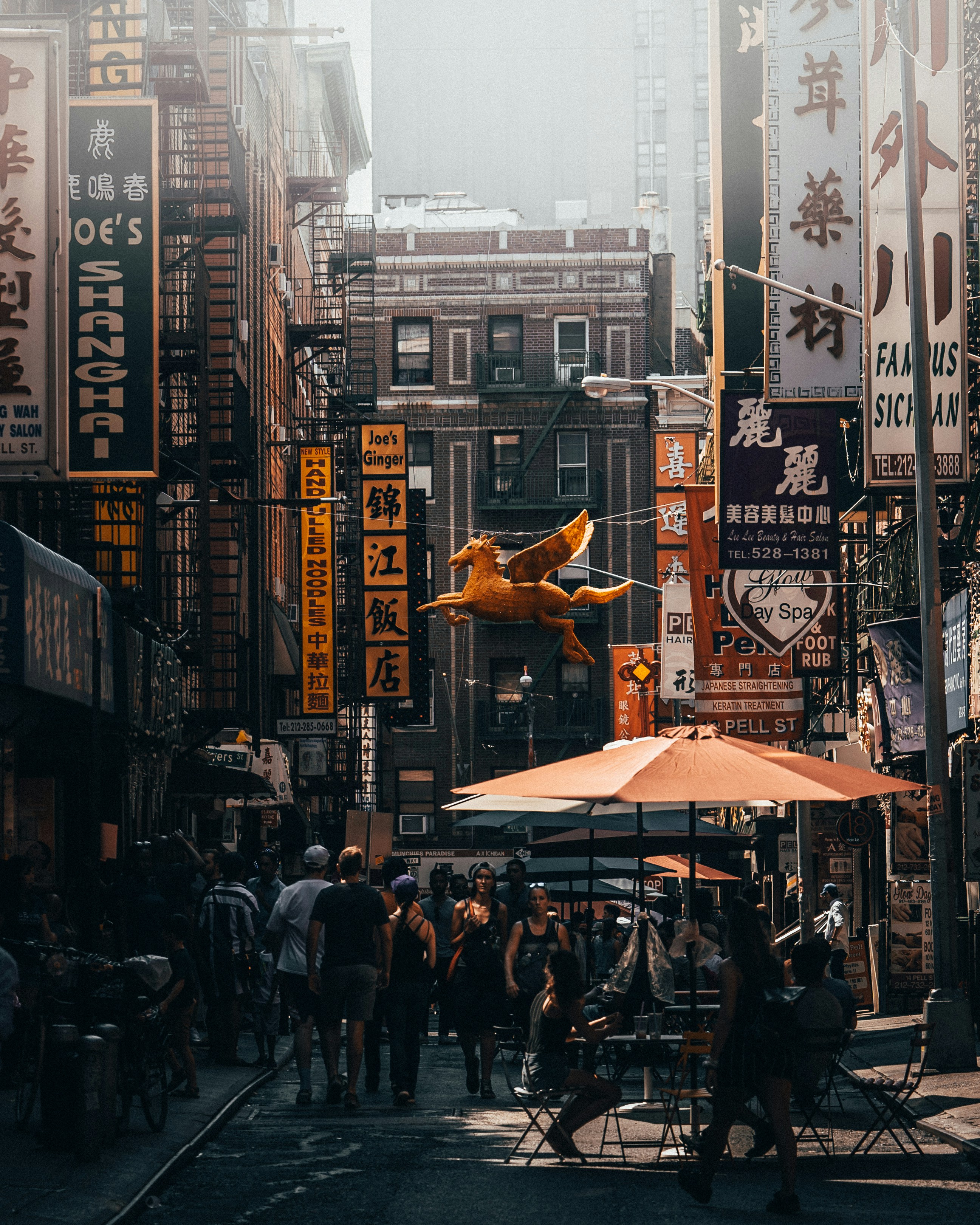 Group of people walking between buildings photo – Free City Image on ...