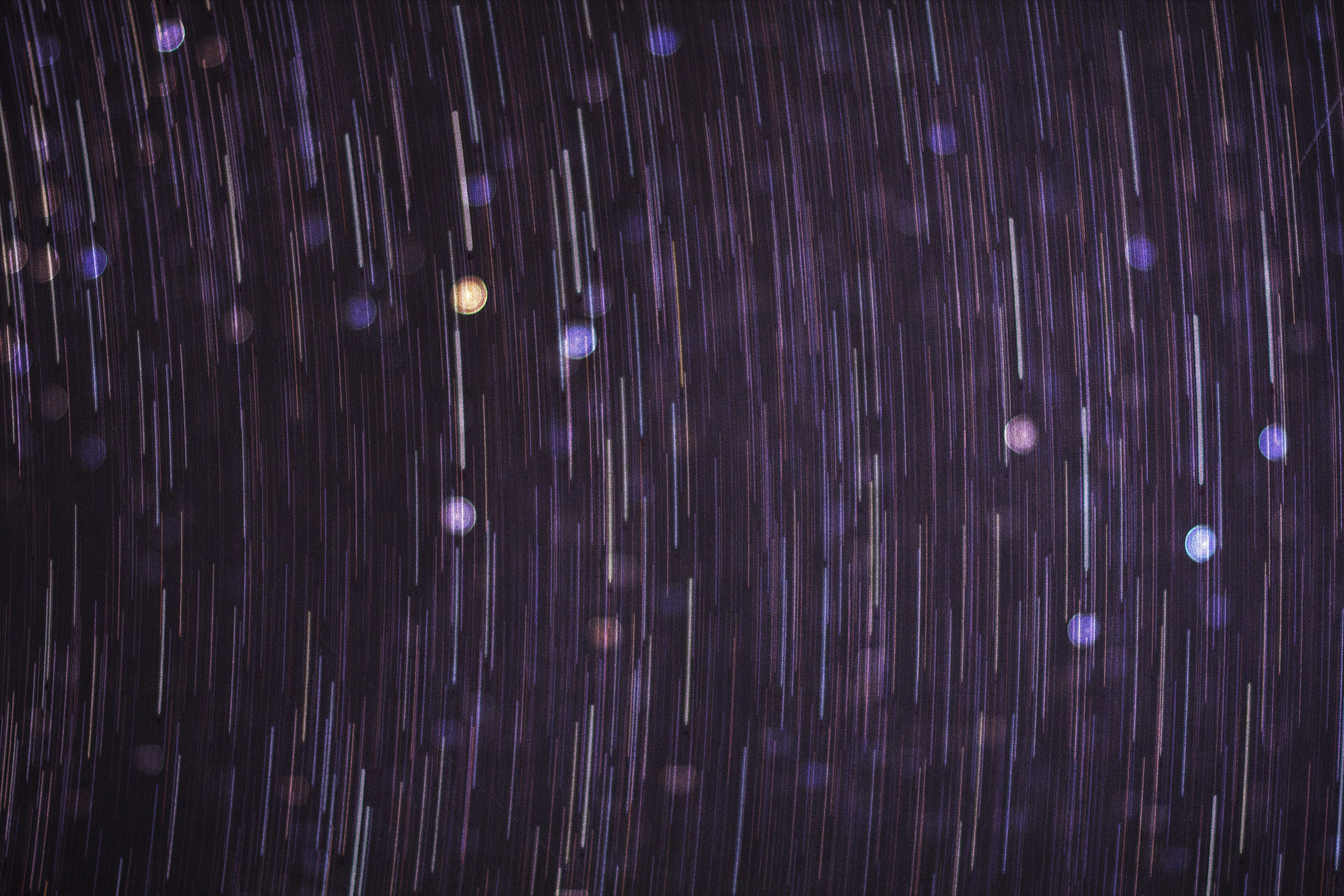 Star trails arch across a dark sky, creating a mesmerizing pattern of light streaks.