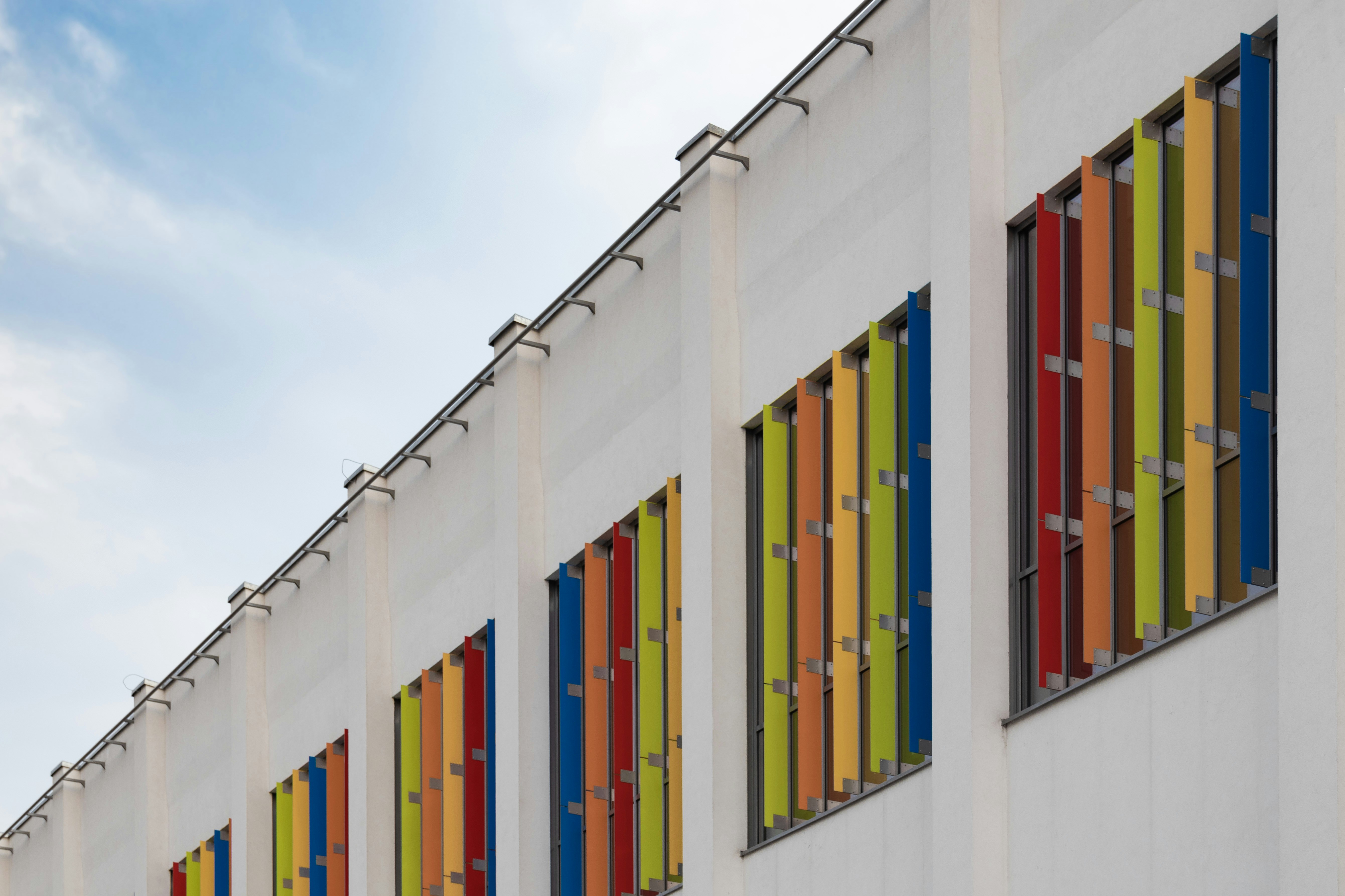 Rainbow Vertical Slats on White Facade