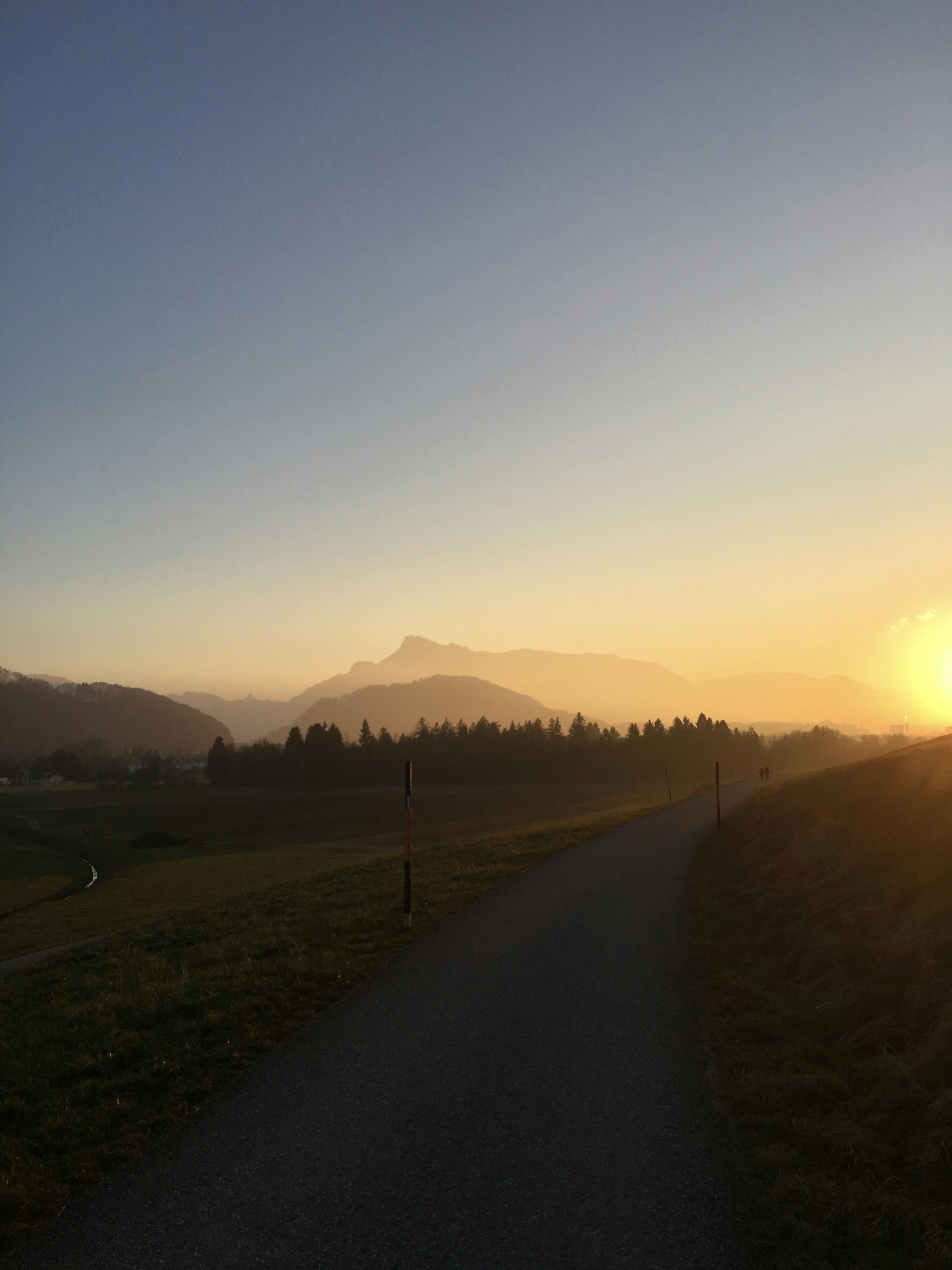 Sunlit Path to a Distant Mountain Ridge at Golden Hour