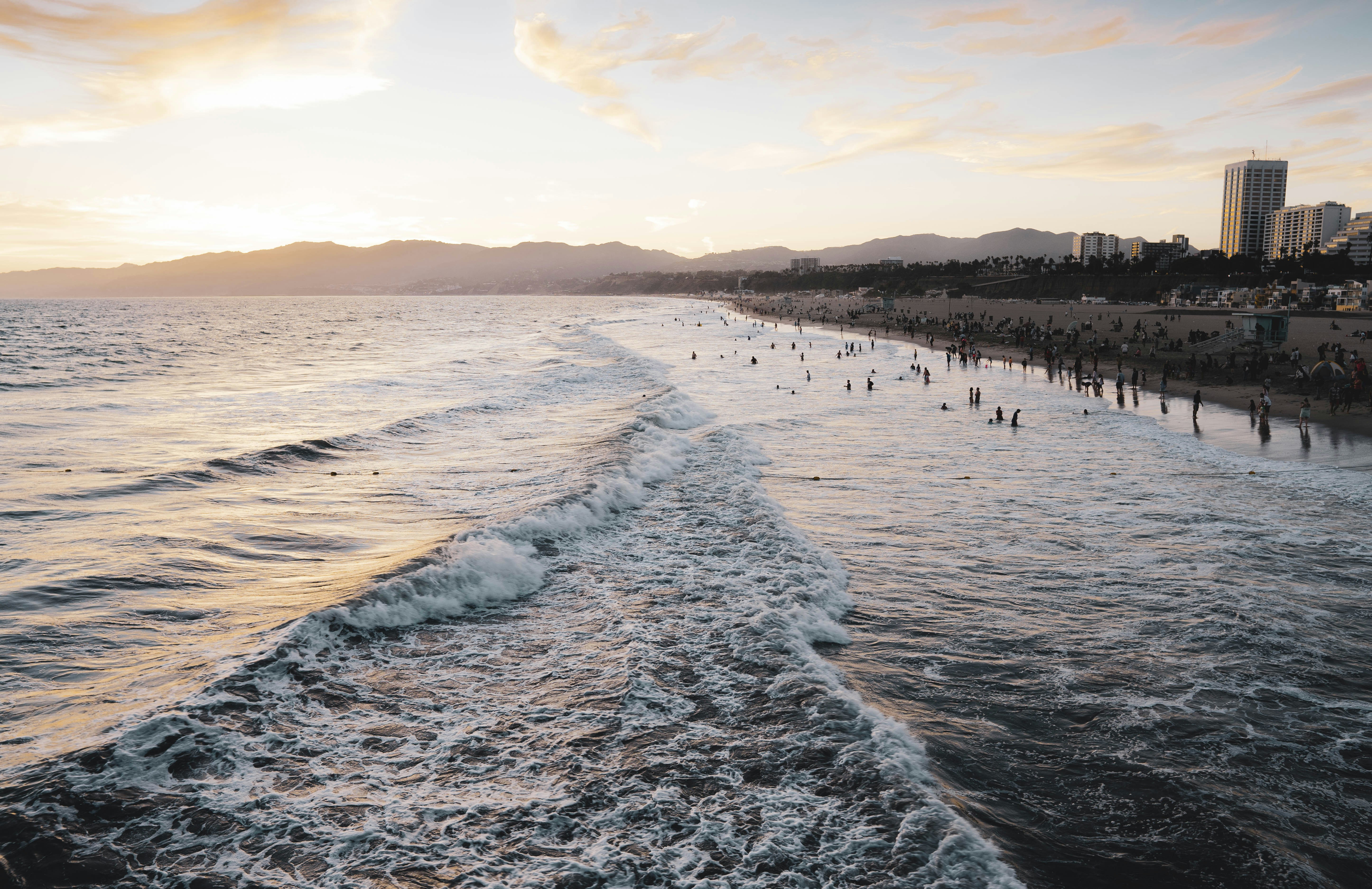 Foam Lines at Golden Hour: A Coastal City Skyline in View
