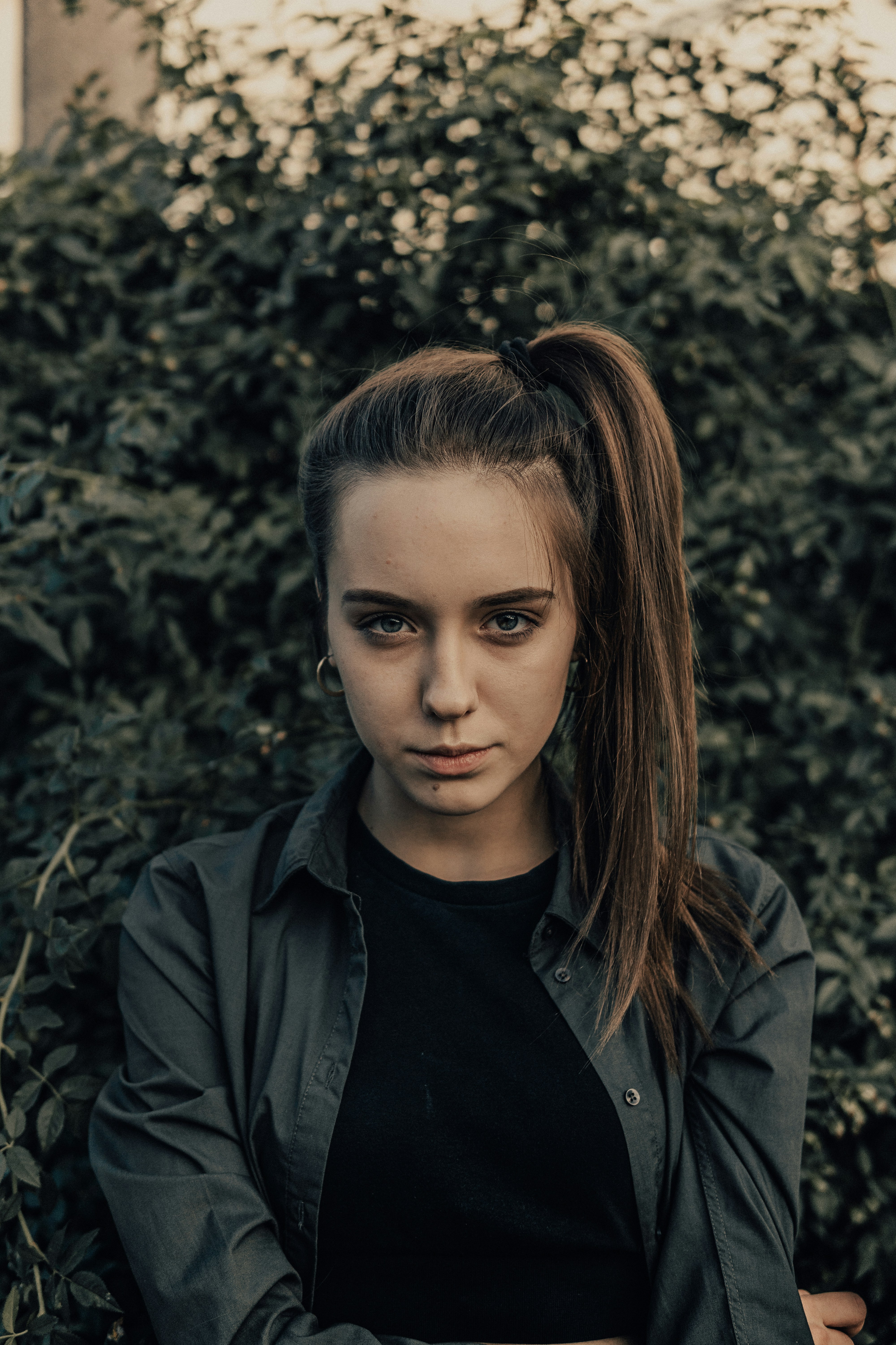 @lix_yang | man wearing black dress shirt in front of green plant